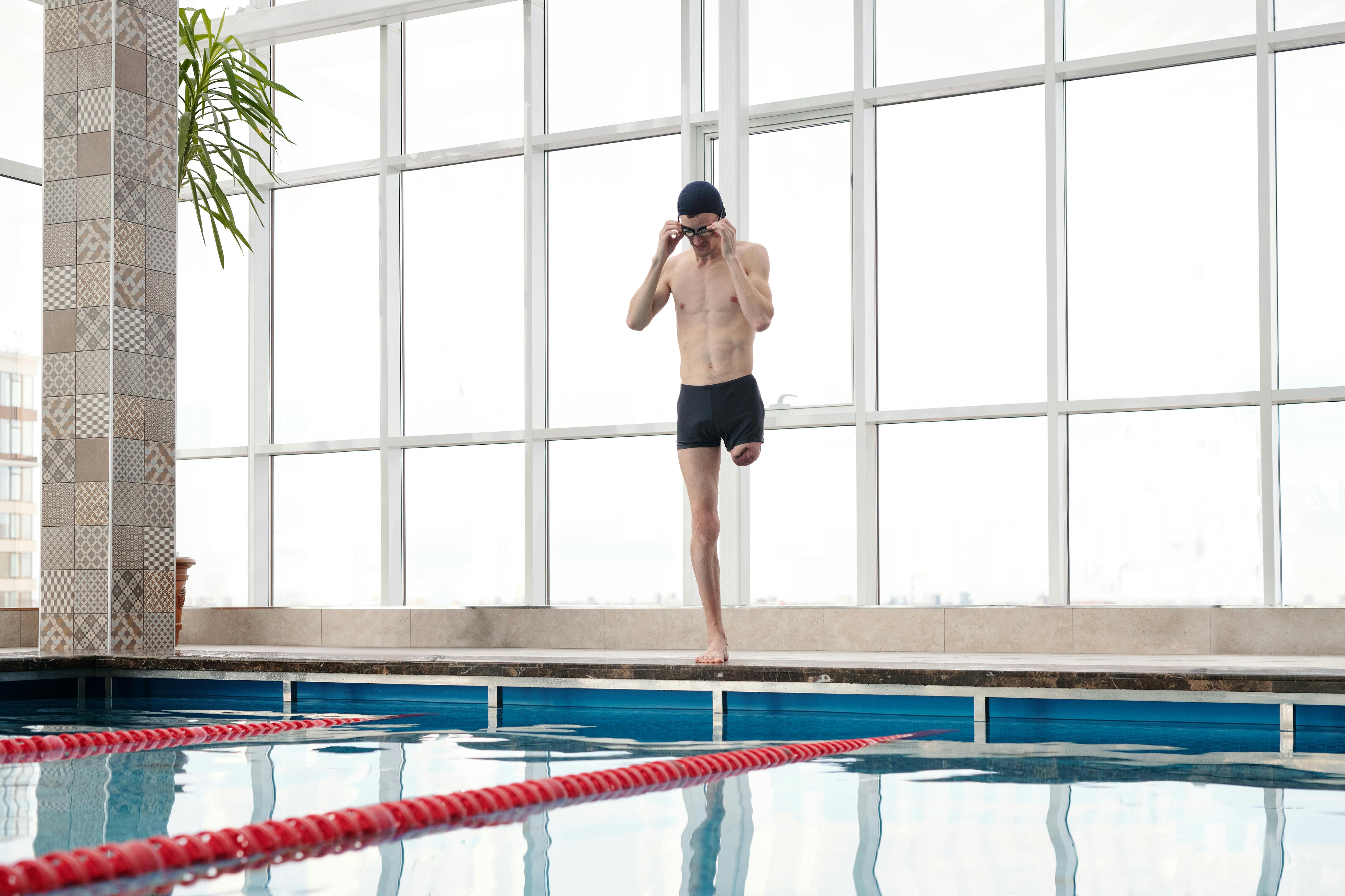 Back View of Man Standing by Swimming Pool · Free Stock Photo