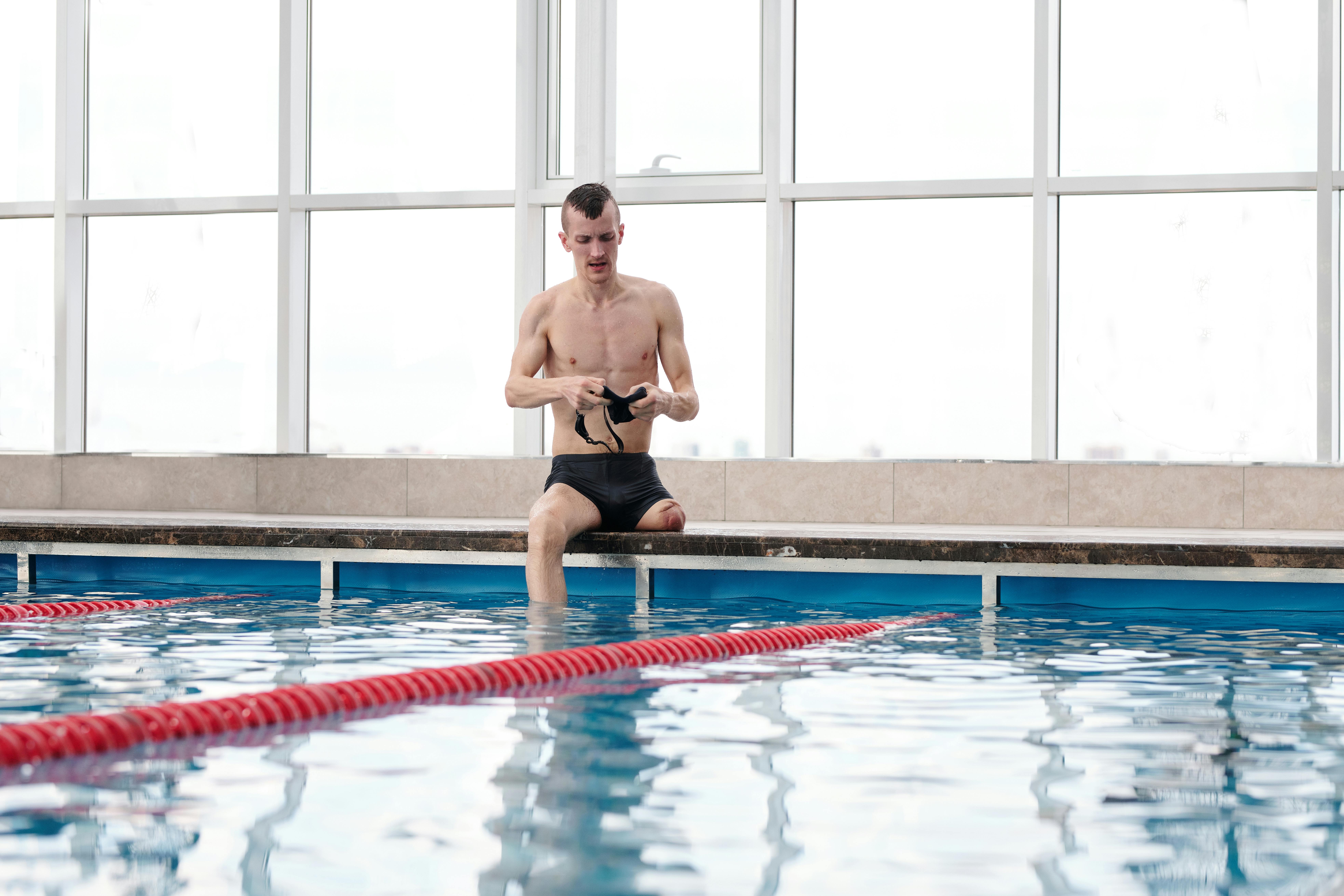 Man Sitting Poolside · Free Stock Photo
