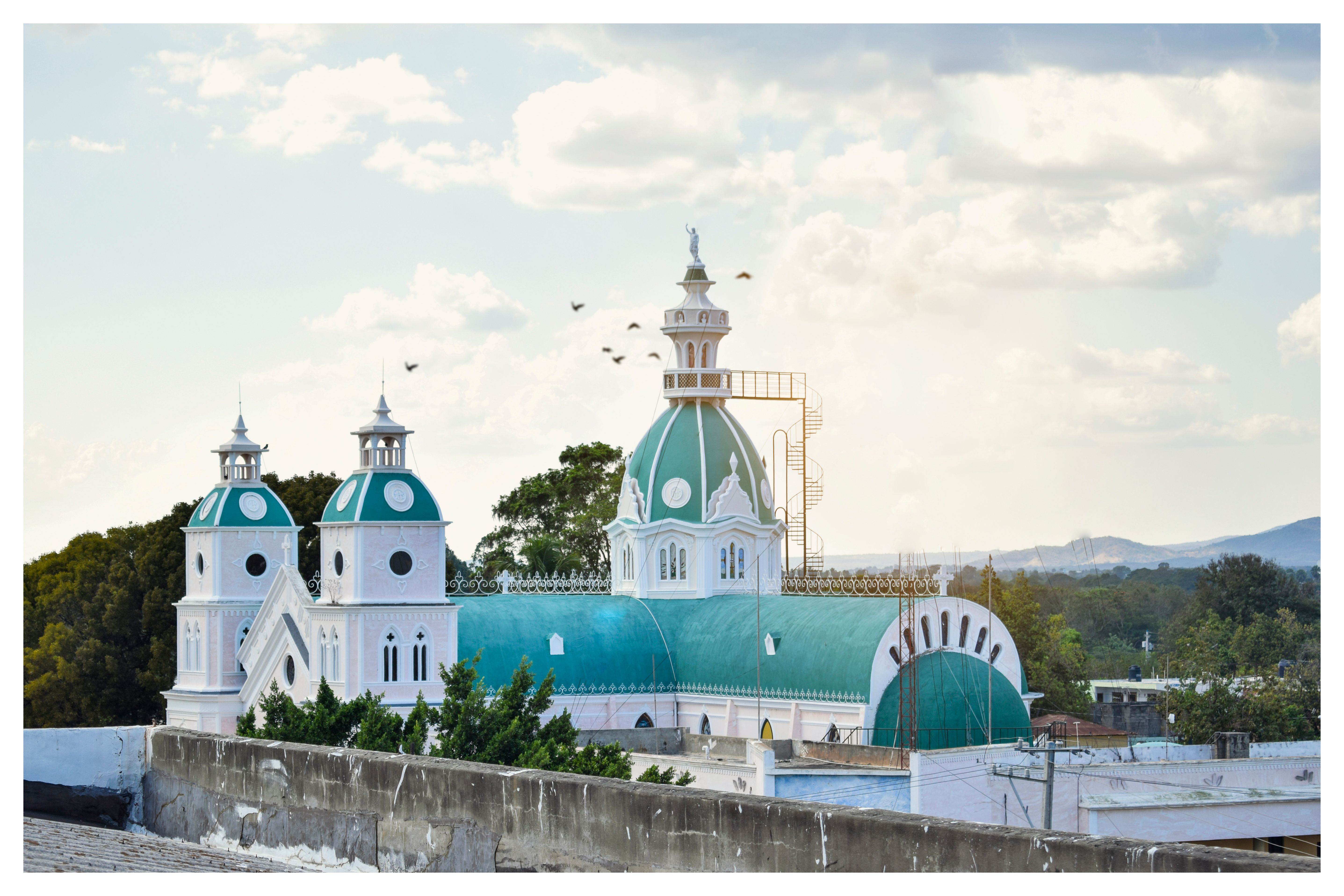 Old church with spire on top under cloudy sky · Free Stock Photo