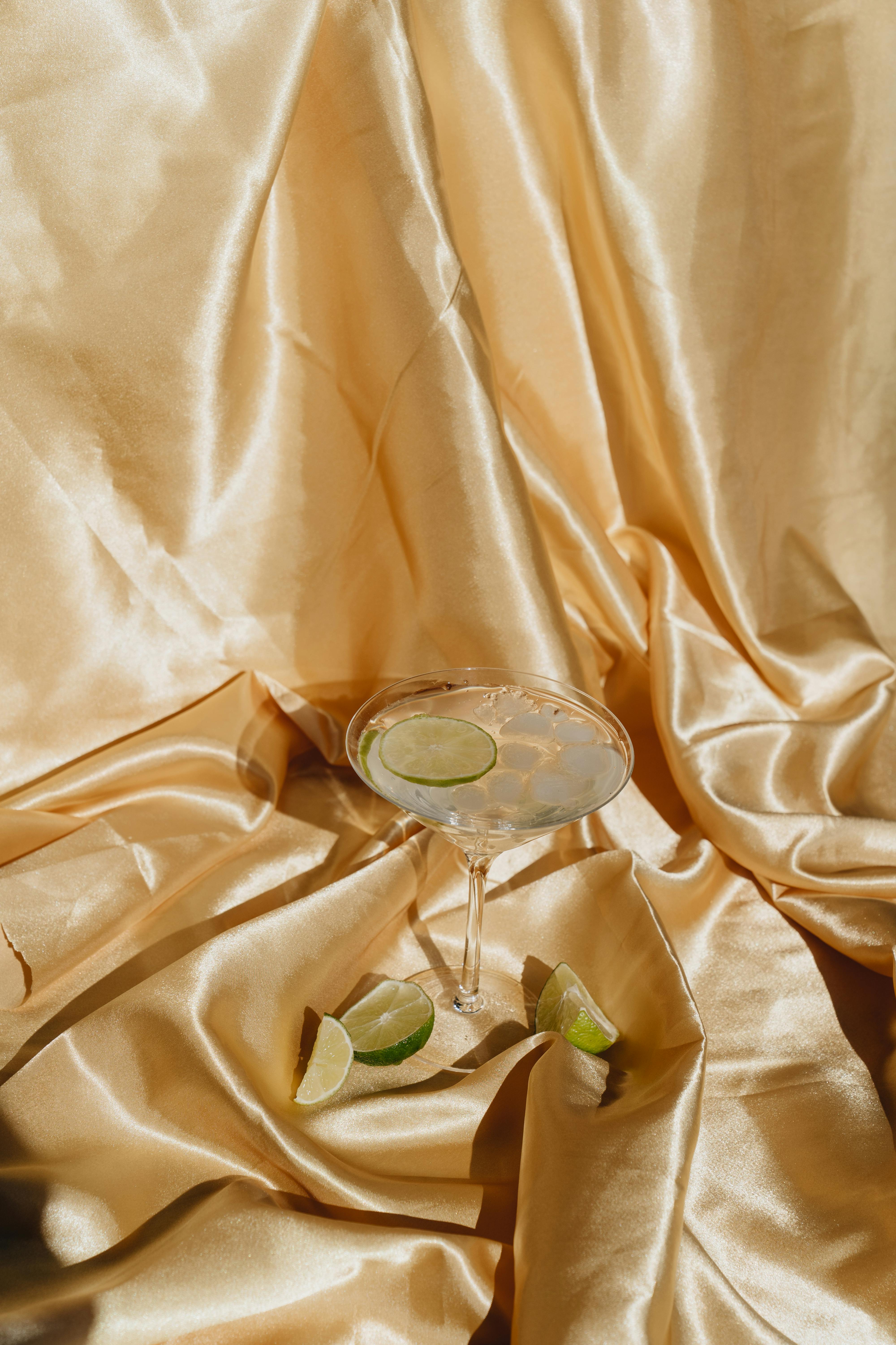 Photo Of Cocktail Glass On Silk Fabric · Free Stock Photo