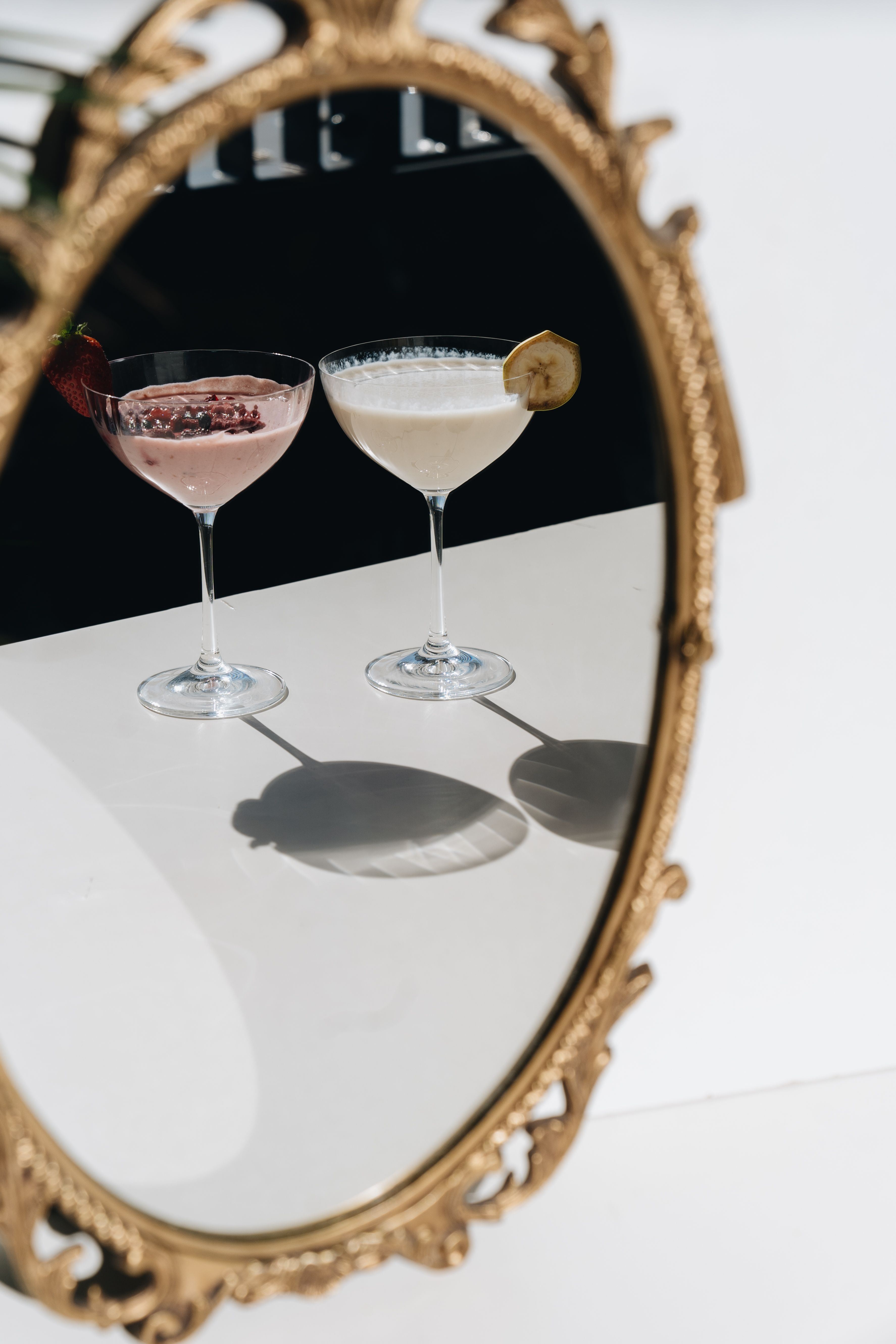 Reflection of Cocktail Drinks on a White Surface · Free Stock Photo