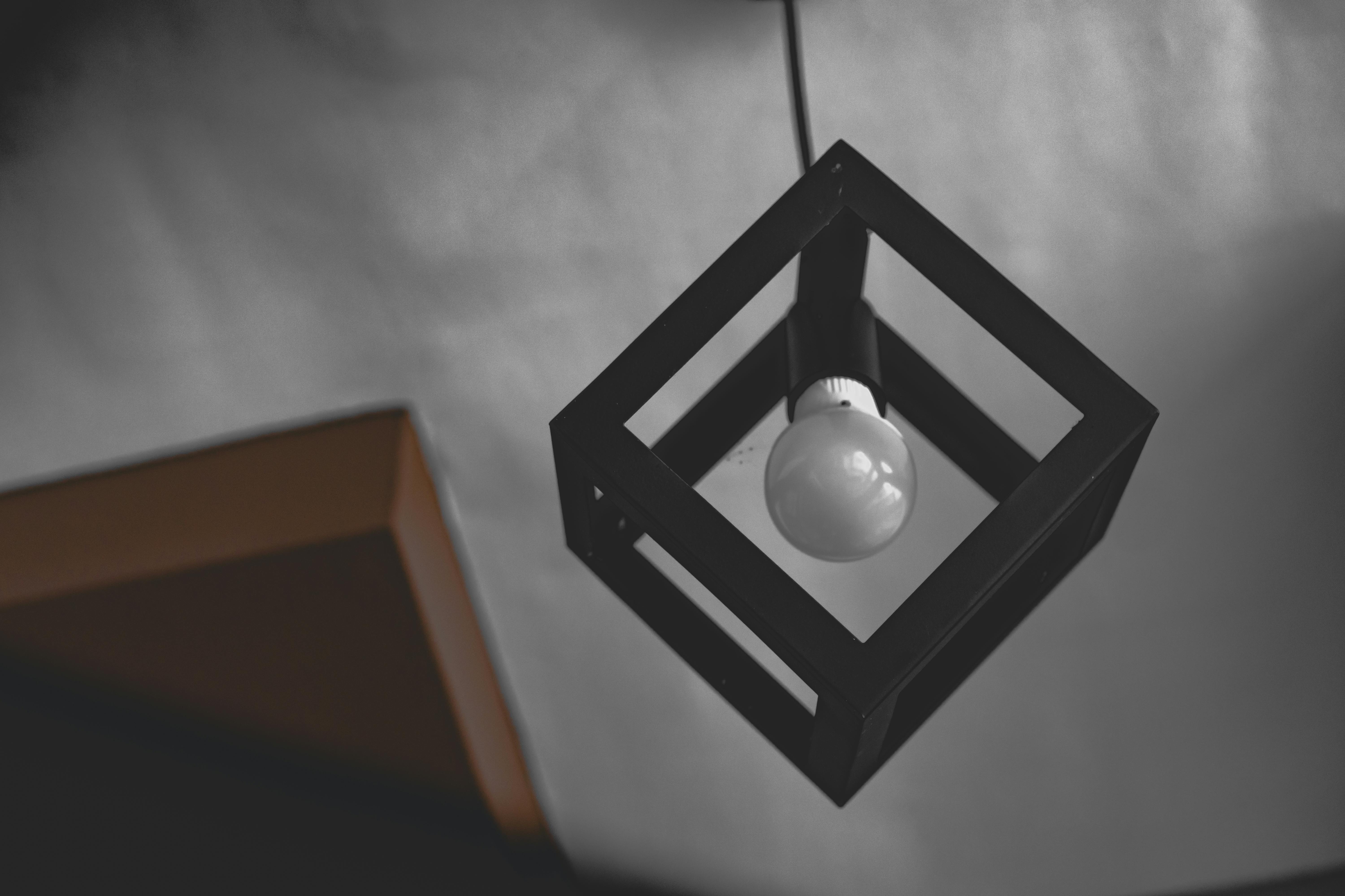 Hanging White Light Bulb on Black Frame · Free Stock Photo