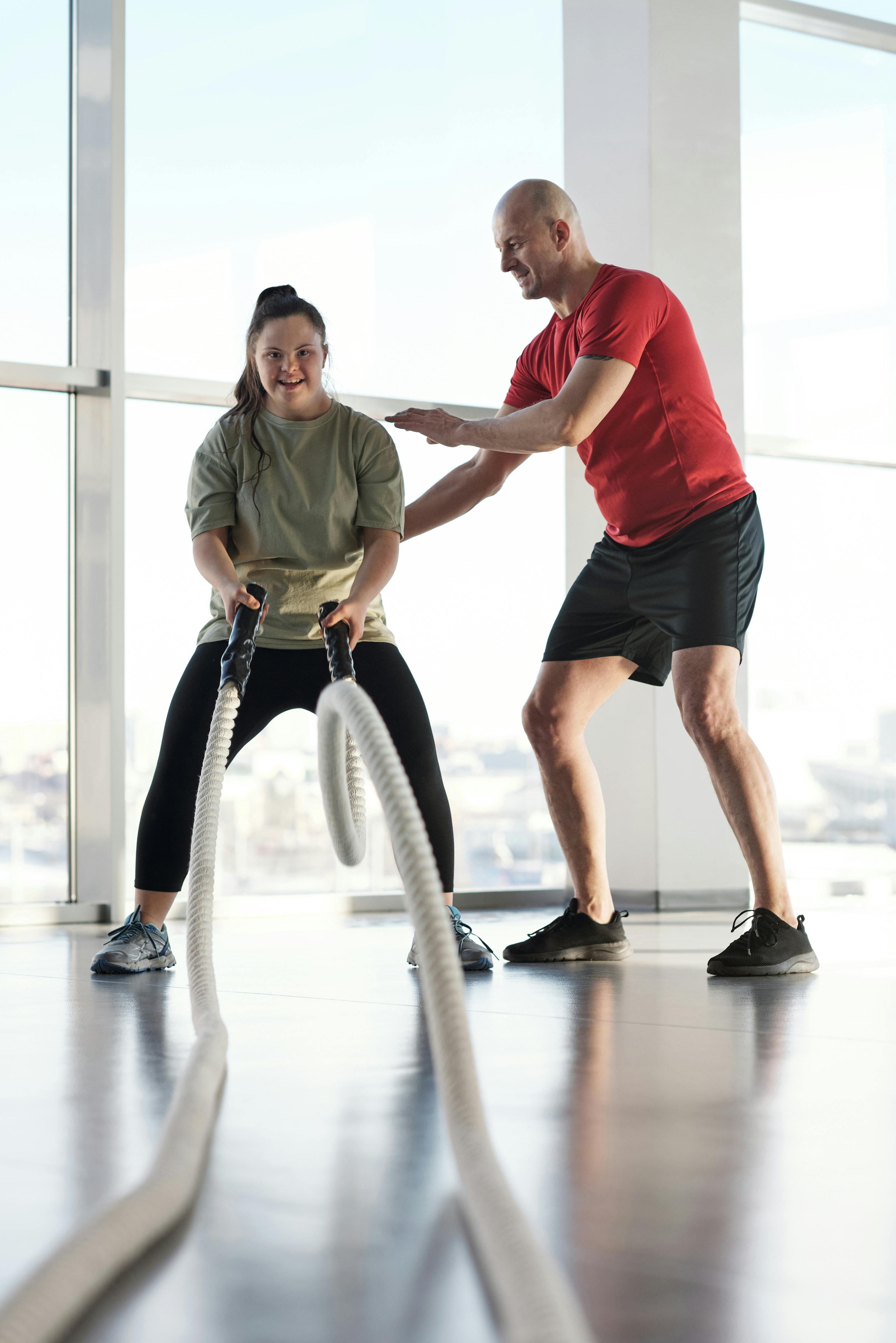 Woman Holding Ropes Beside a Trainer · Free Stock Photo