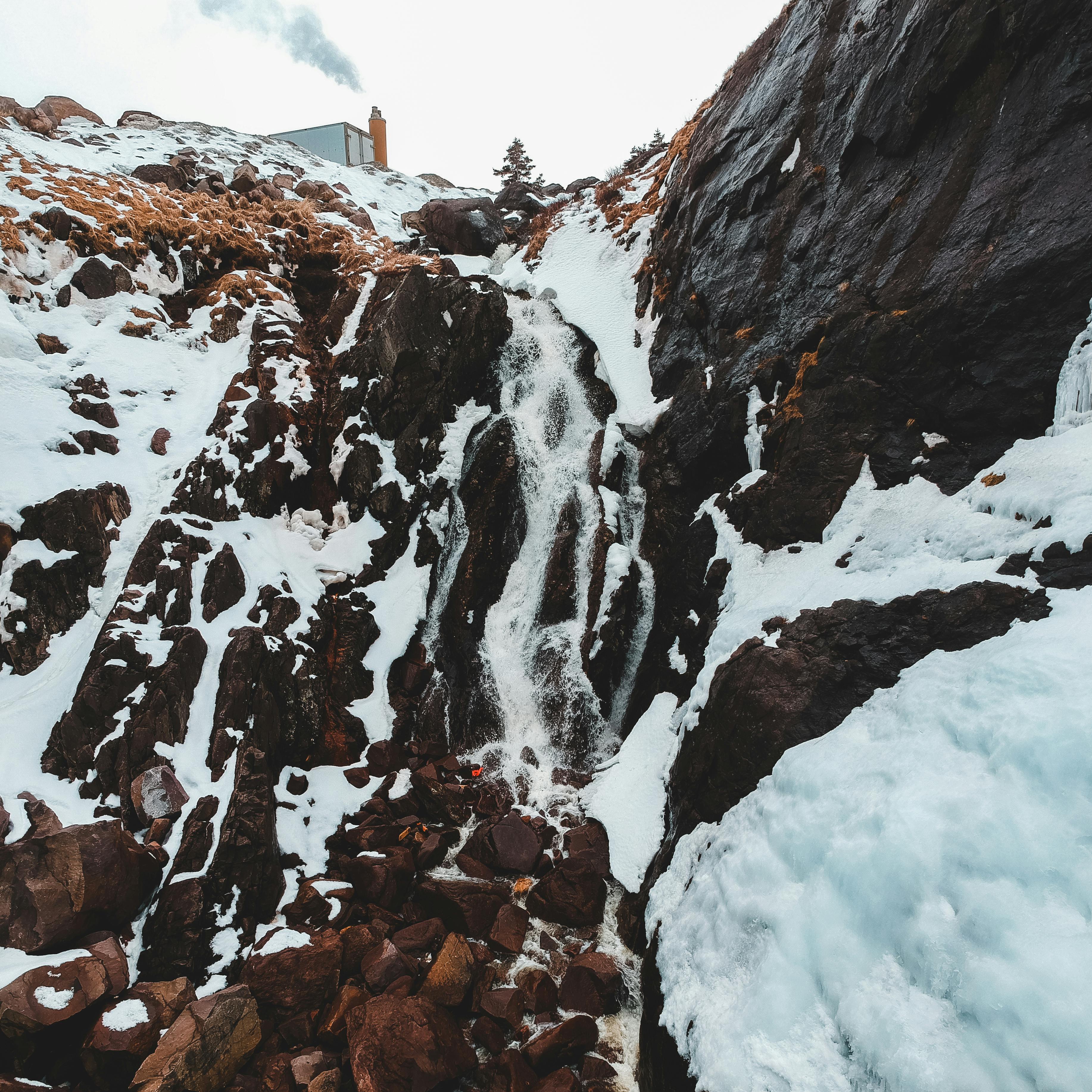 Cold waterfall on high mountain cliff · Free Stock Photo