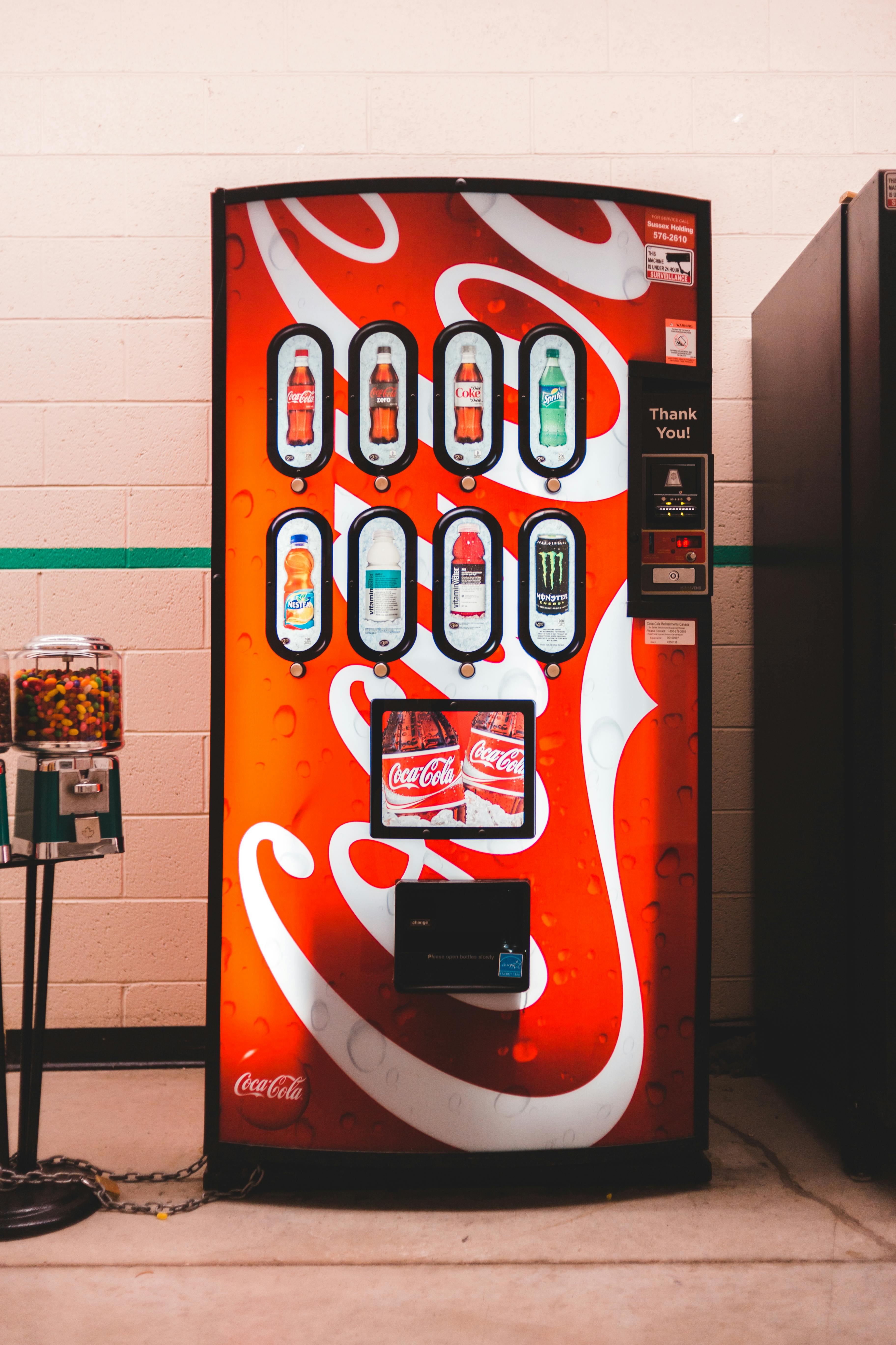 Bright soda and candy machines in building · Free Stock Photo