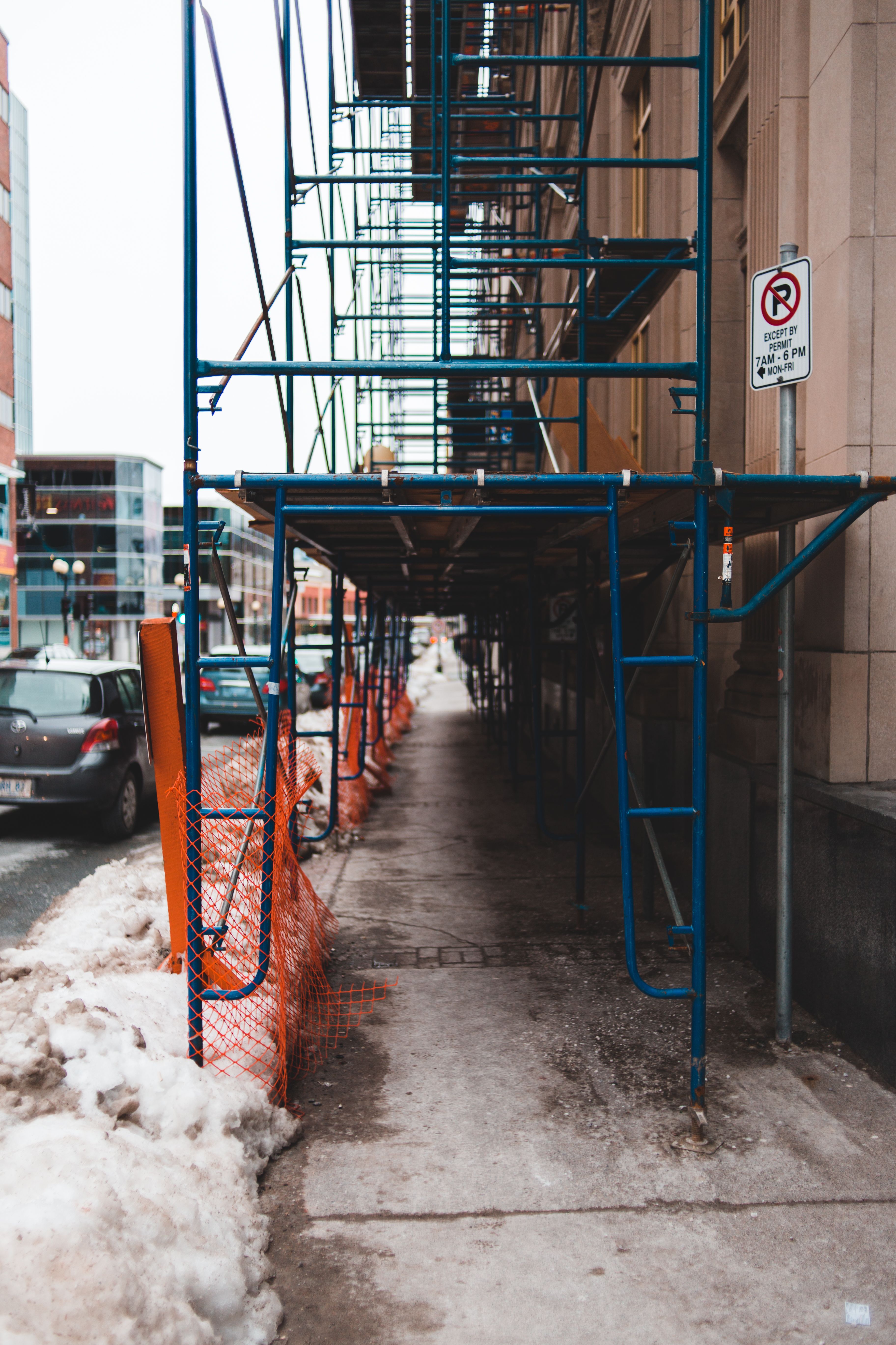 Metal construction on city street during old building restoration ...