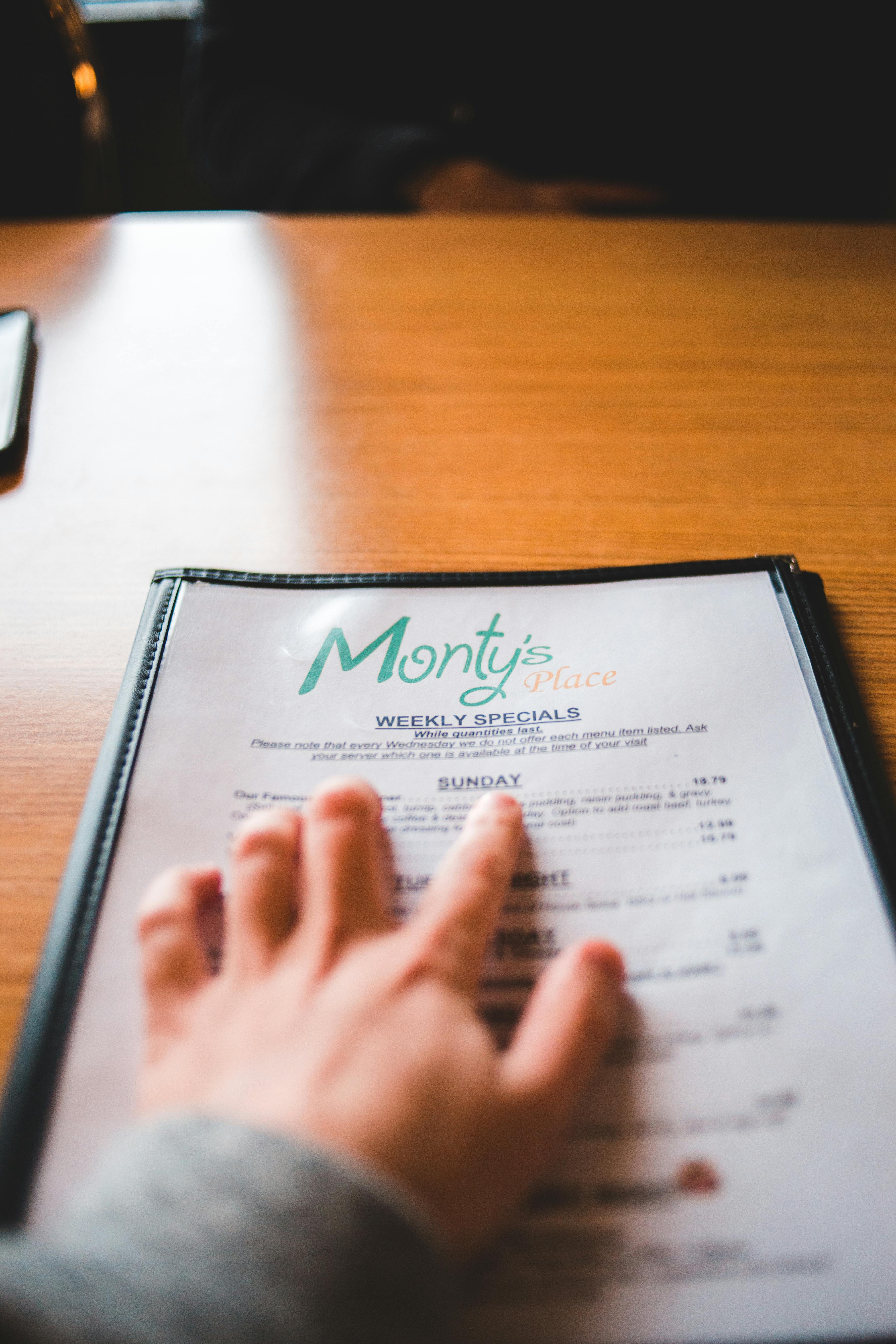 Person Holding Menu Board · Free Stock Photo