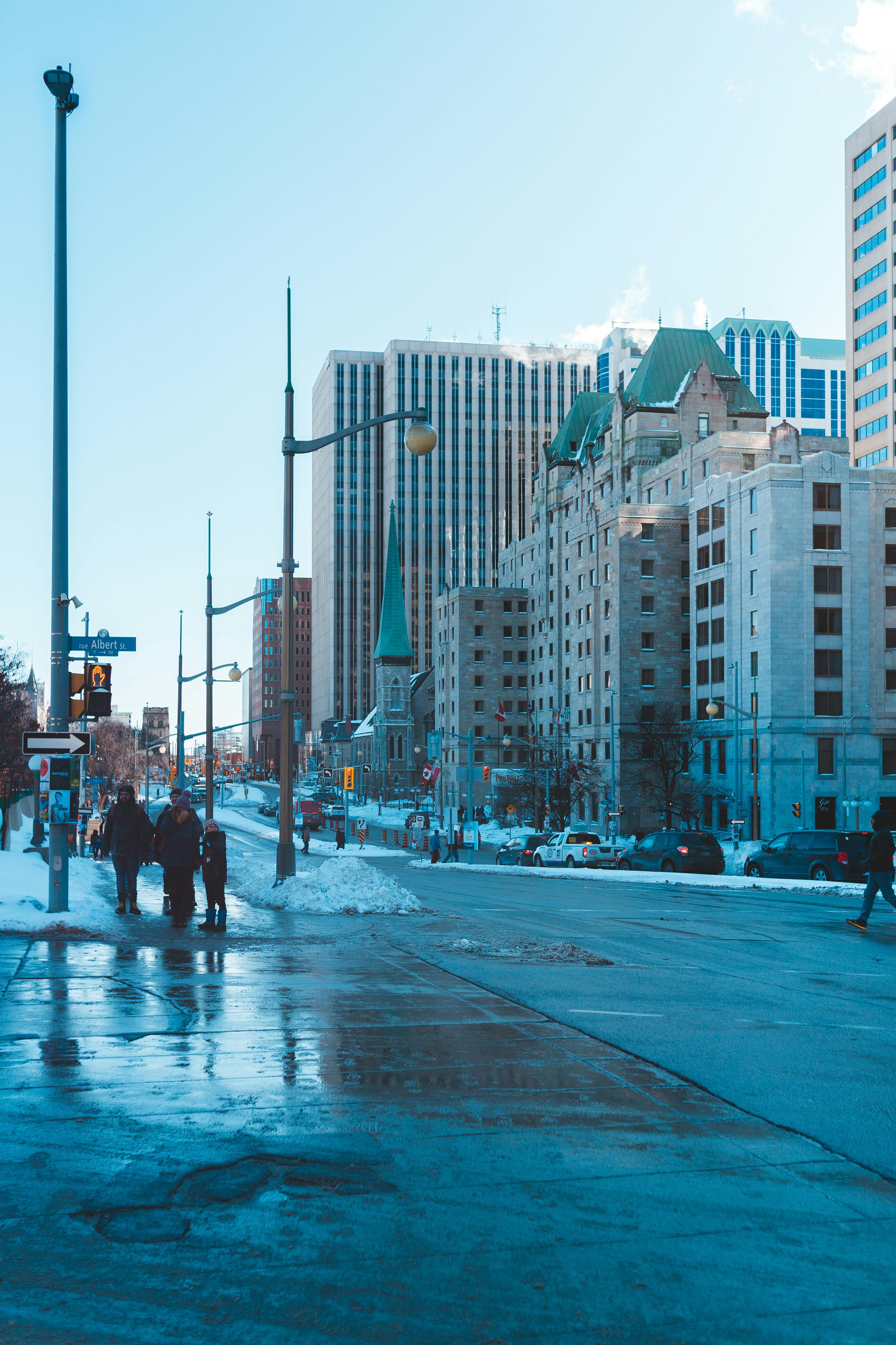 People Walking on Sidewalk Near High Rise Buildings · Free Stock Photo