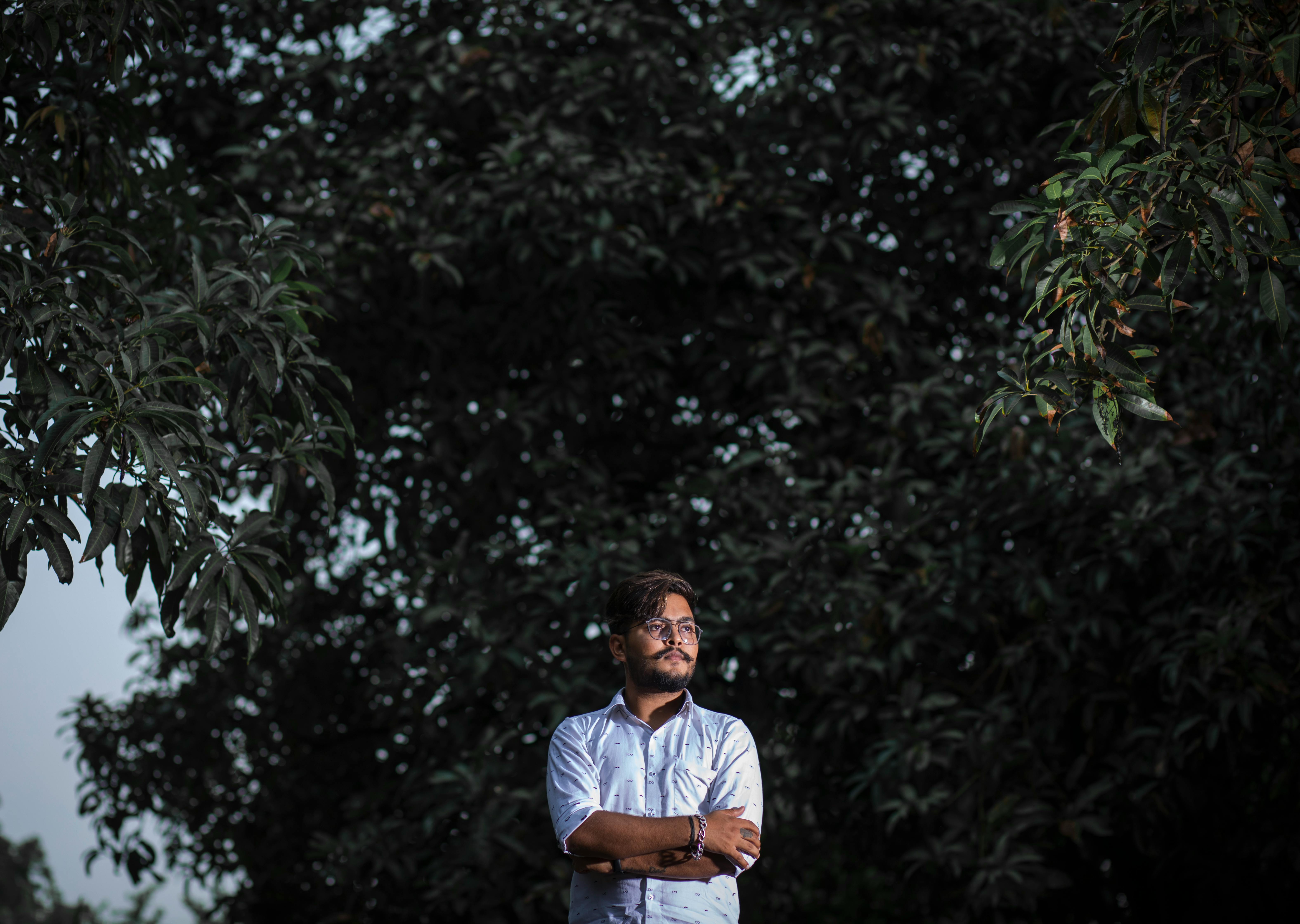 Man Holding a Stick with Perched Bird · Free Stock Photo