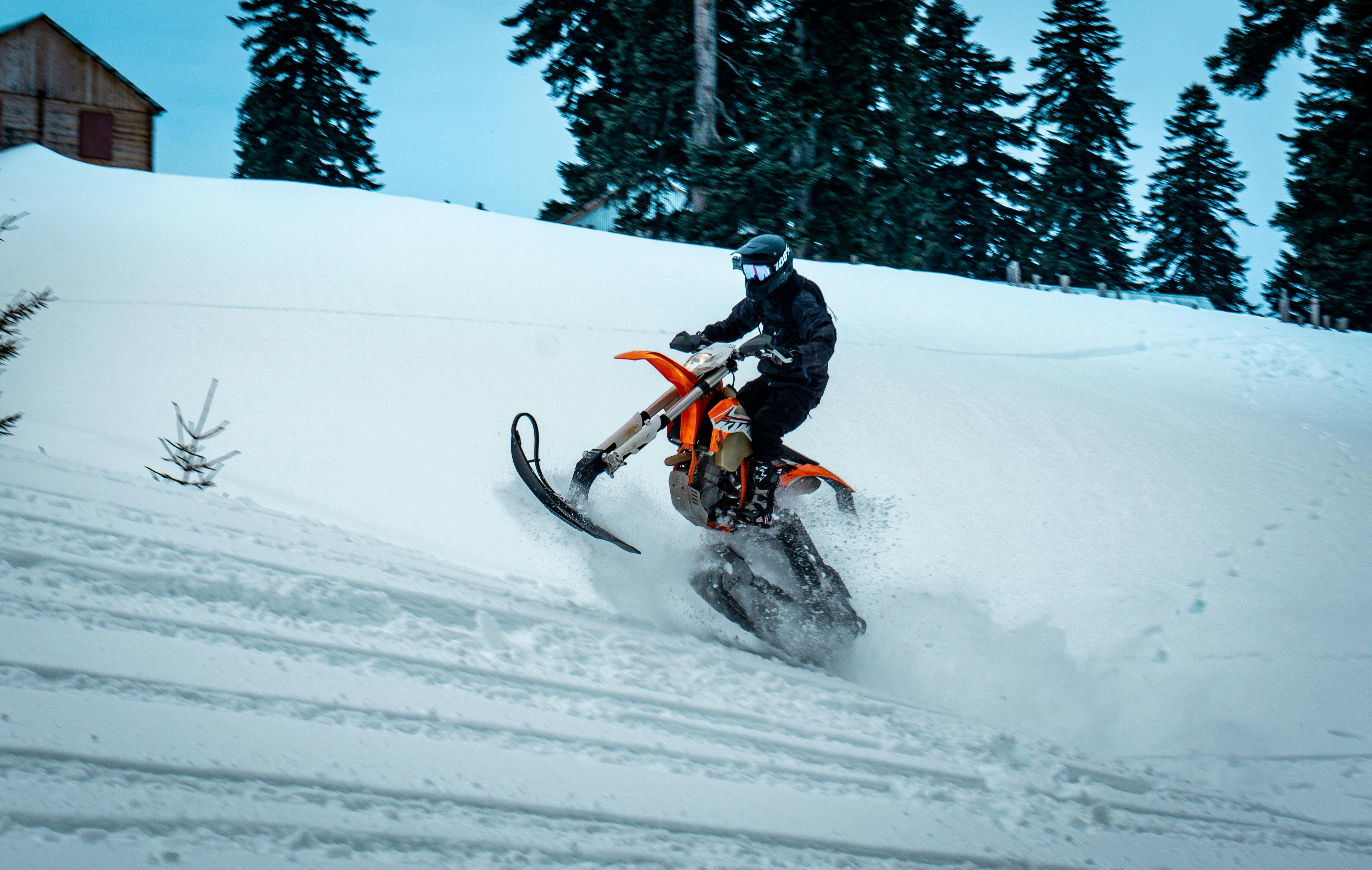 Unrecognizable man riding snowmobile on snow slope at winter day · Free ...