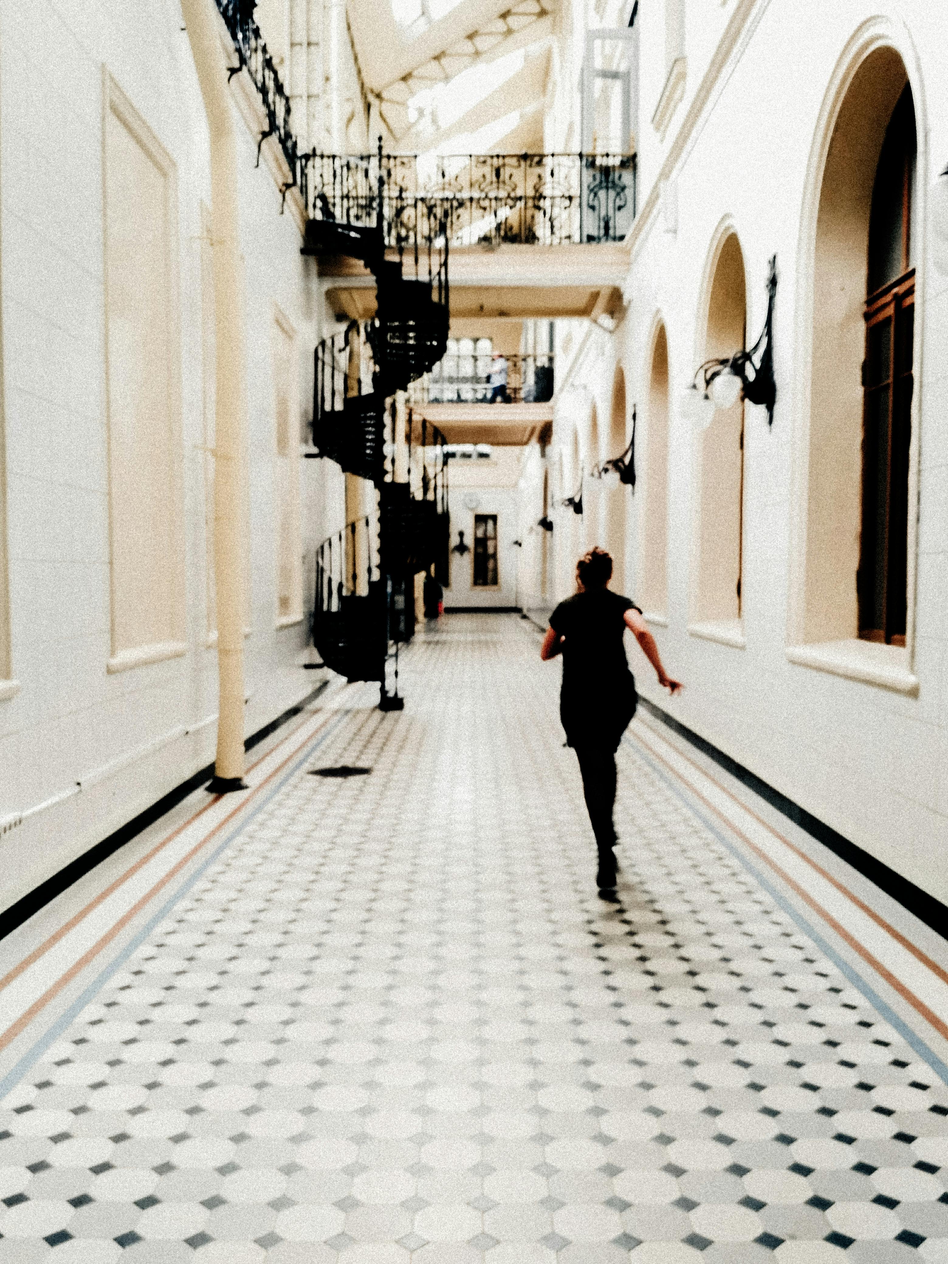 Person Running Down a Hallway · Free Stock Photo