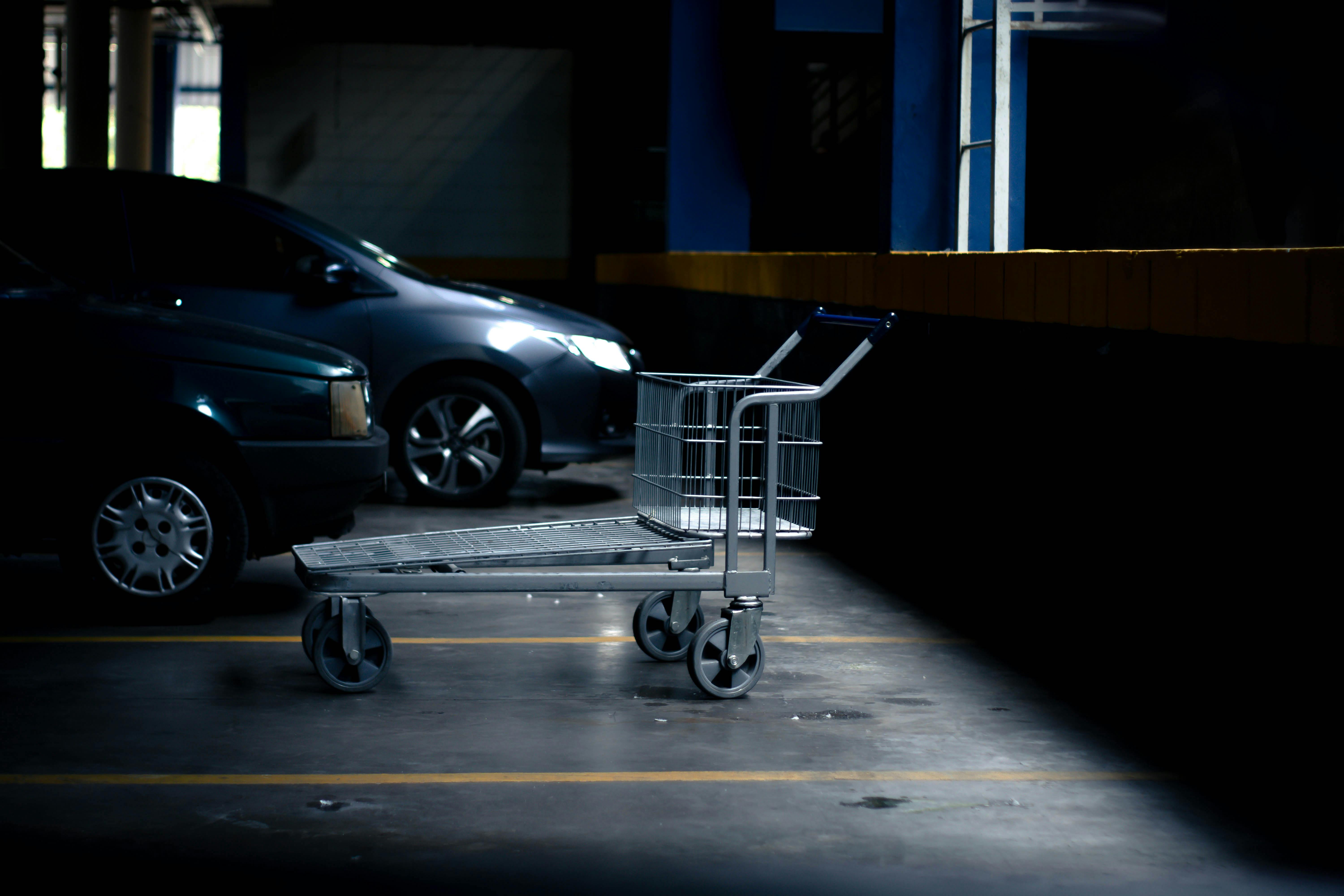 Silver Shopping Cart Beside Black Car · Free Stock Photo