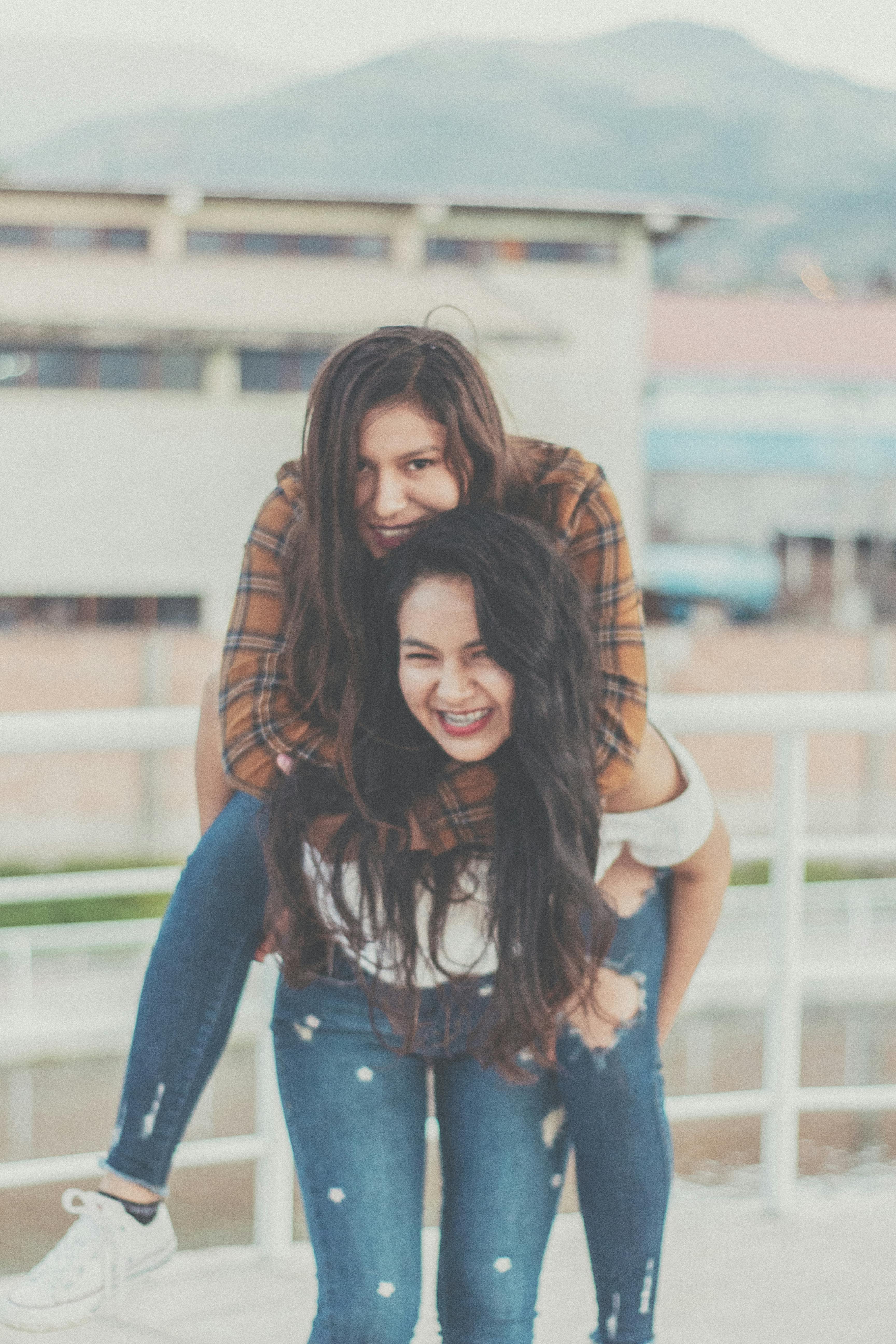 Woman Carrying a Friend on Her Back · Free Stock Photo
