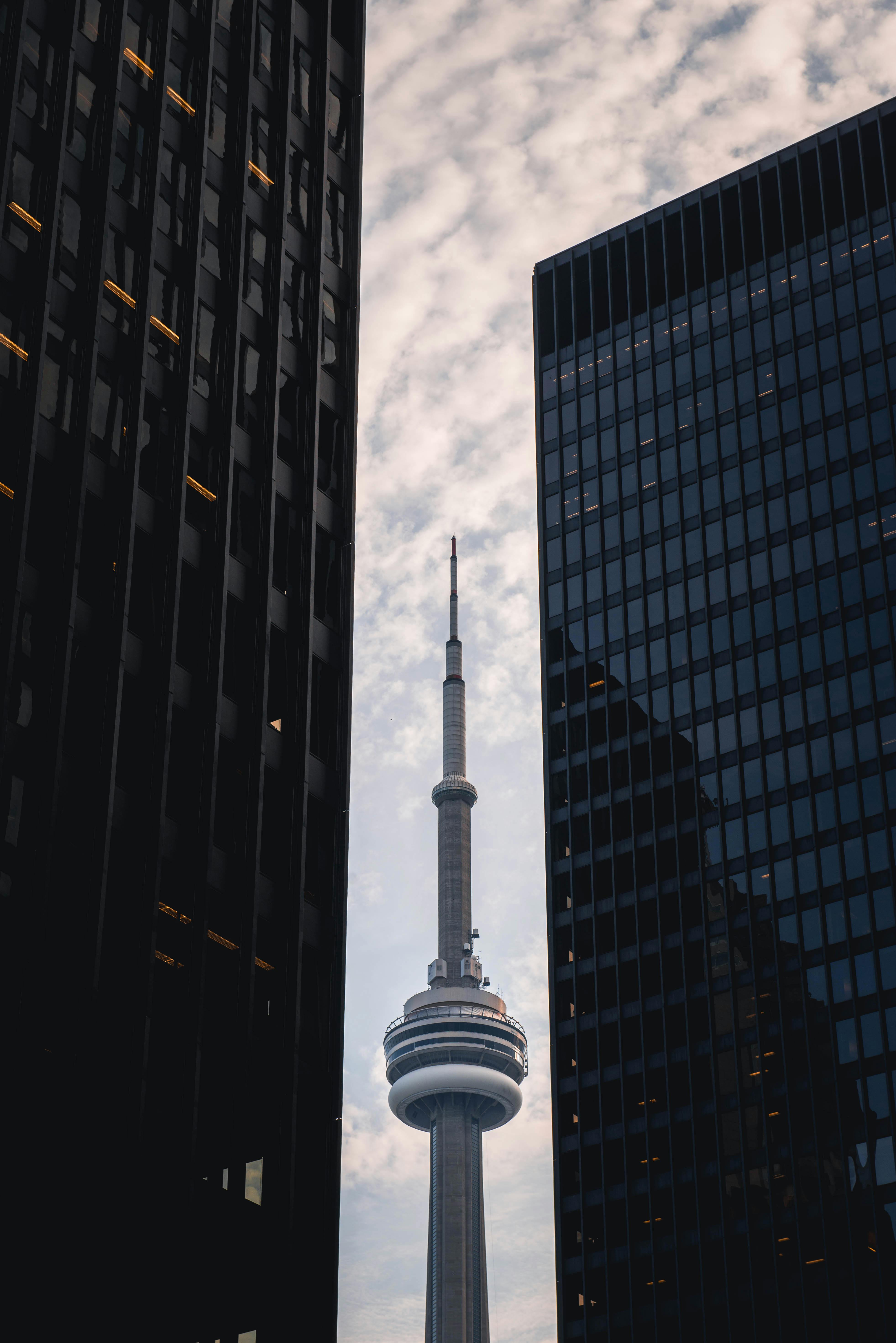 Observation tower between contemporary glass buildings in downtown ...
