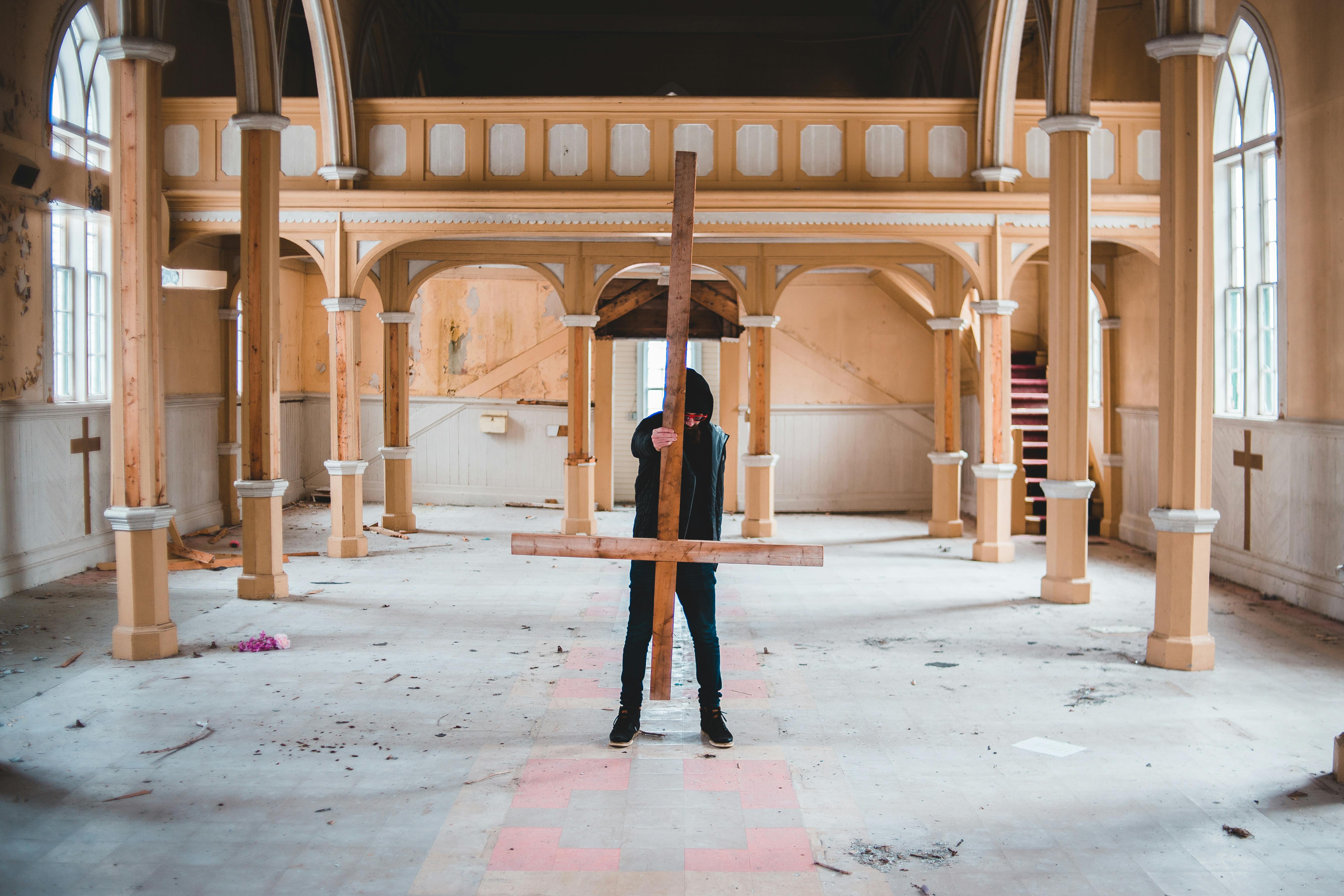 Anonymous person carrying wooden Christian cross · Free Stock Photo