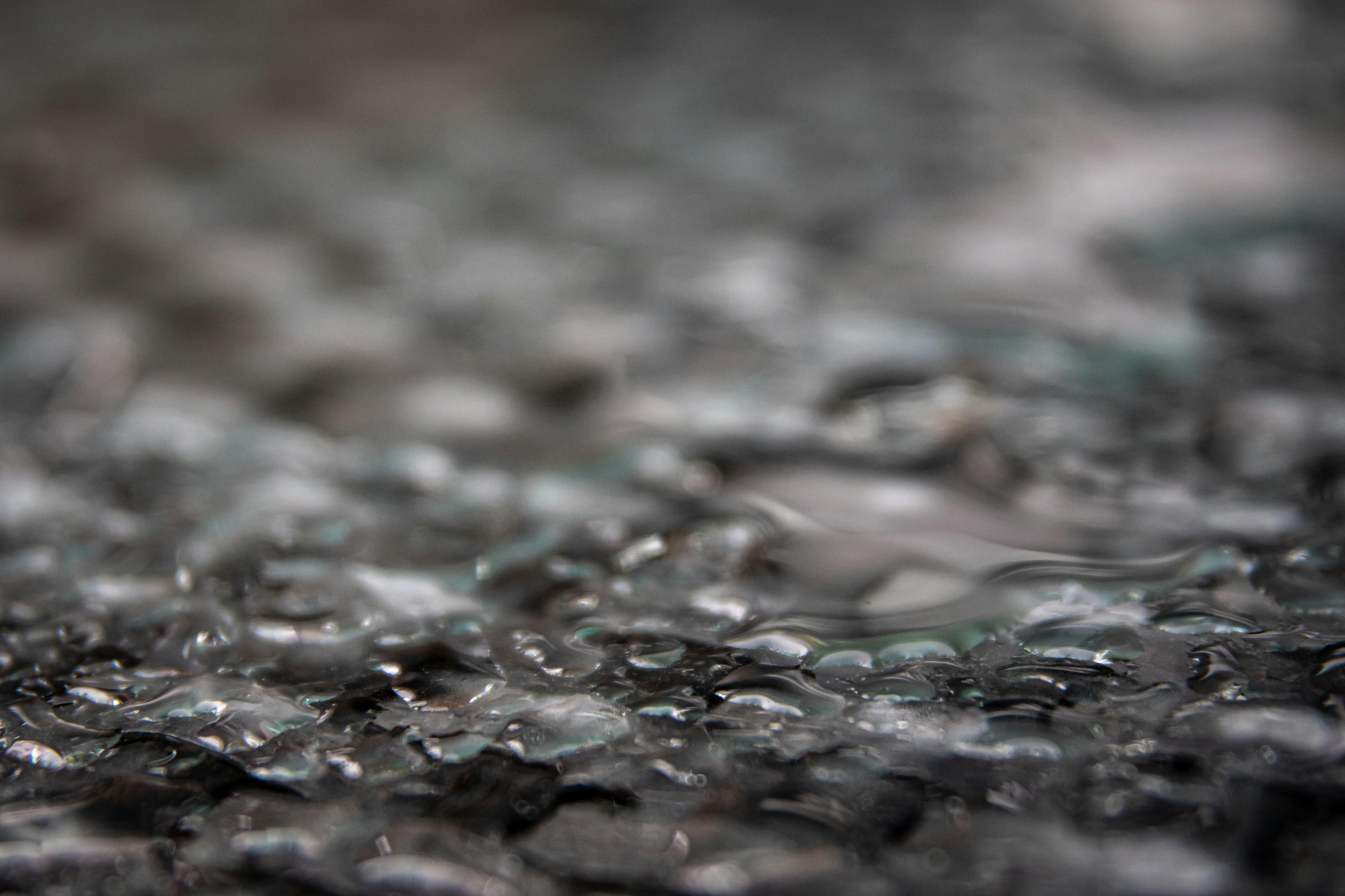 A Close-up Shot of Water Droplets on Gray Surface · Free Stock Photo