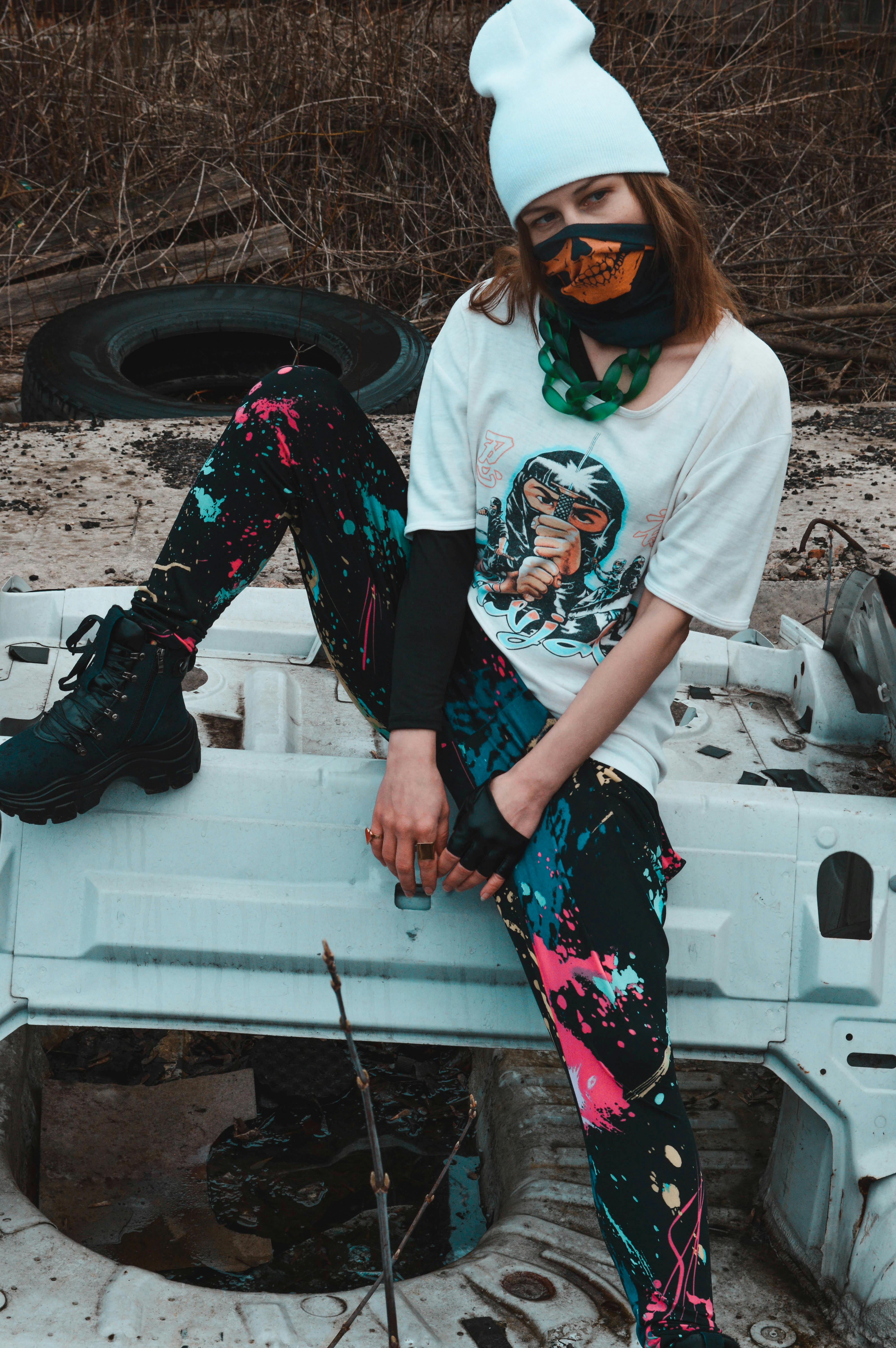 Faceless lady wearing trendy mask sitting on broken car · Free Stock Photo