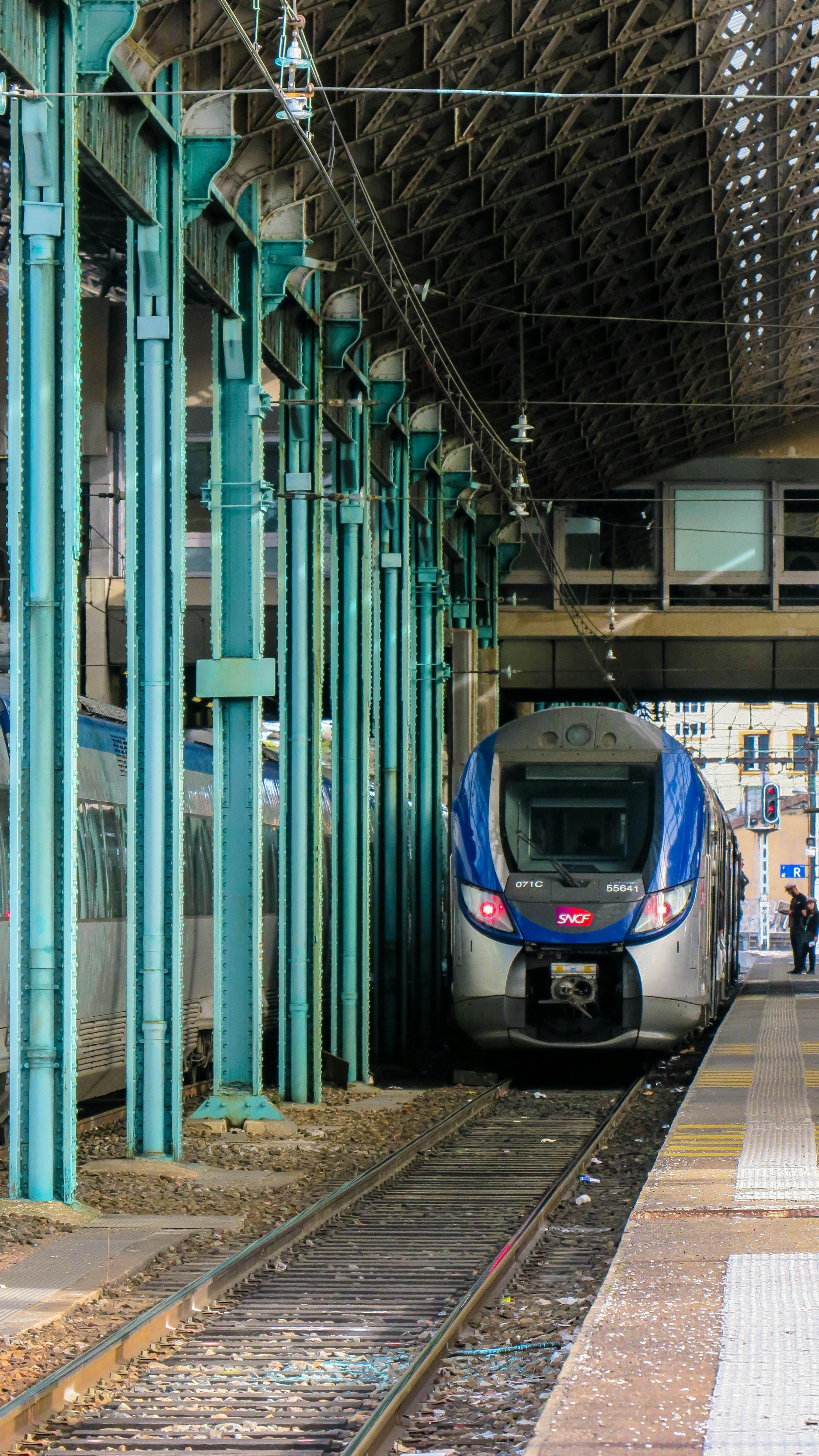 A Silver and Blue Train in a Train Station · Free Stock Photo