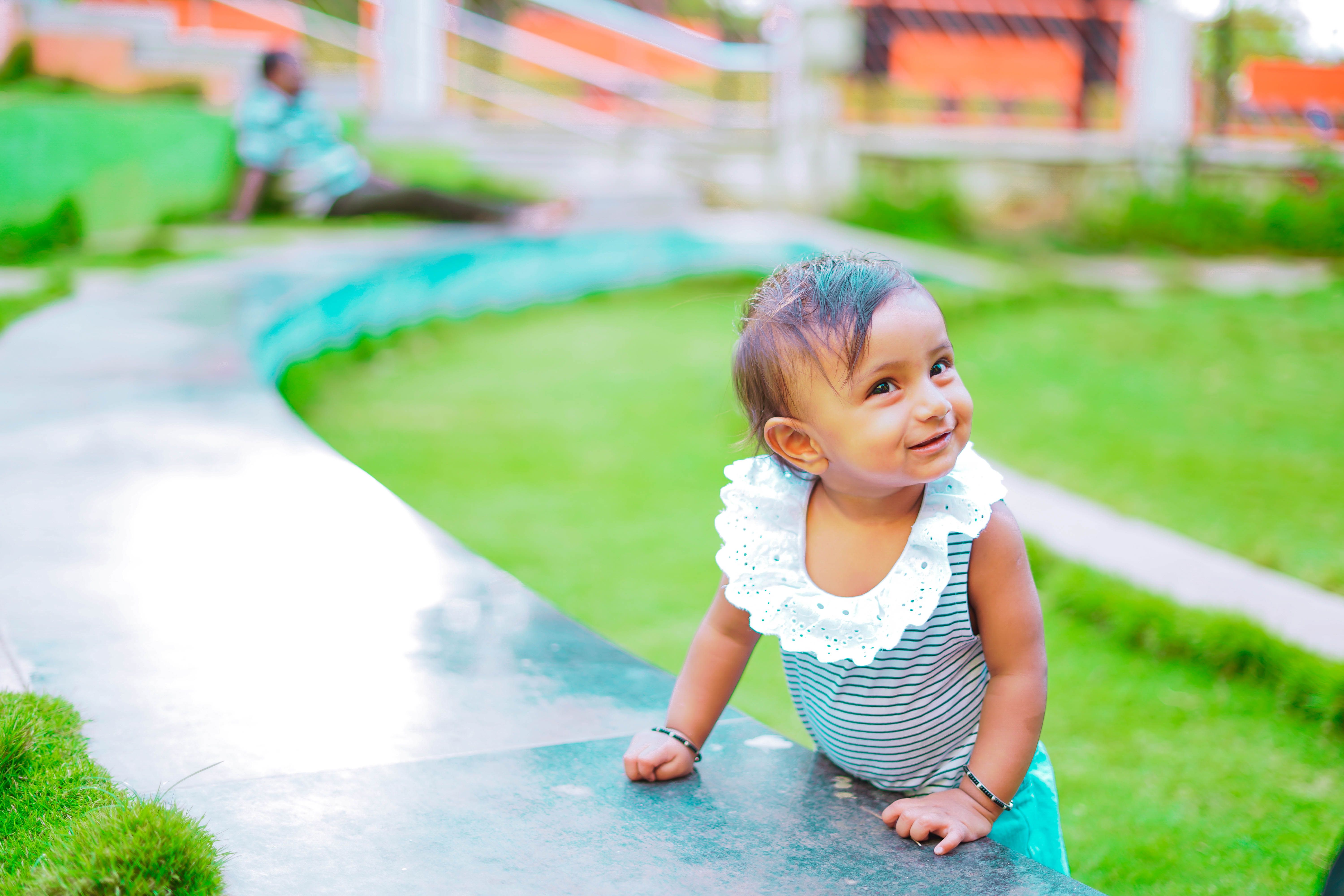 Happy little kid smiling while standing in city ark · Free Stock Photo
