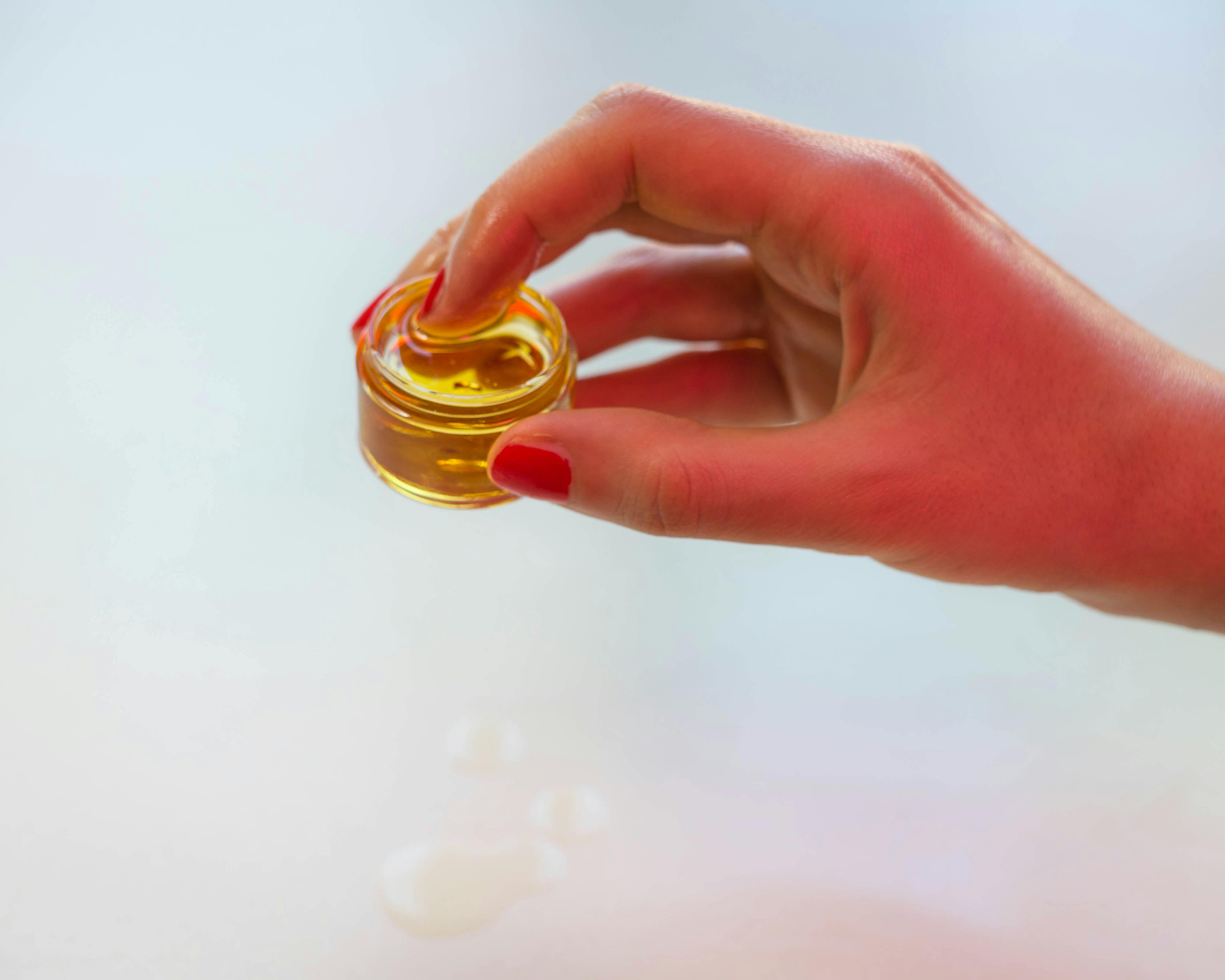 Person Holding a Dropper · Free Stock Photo