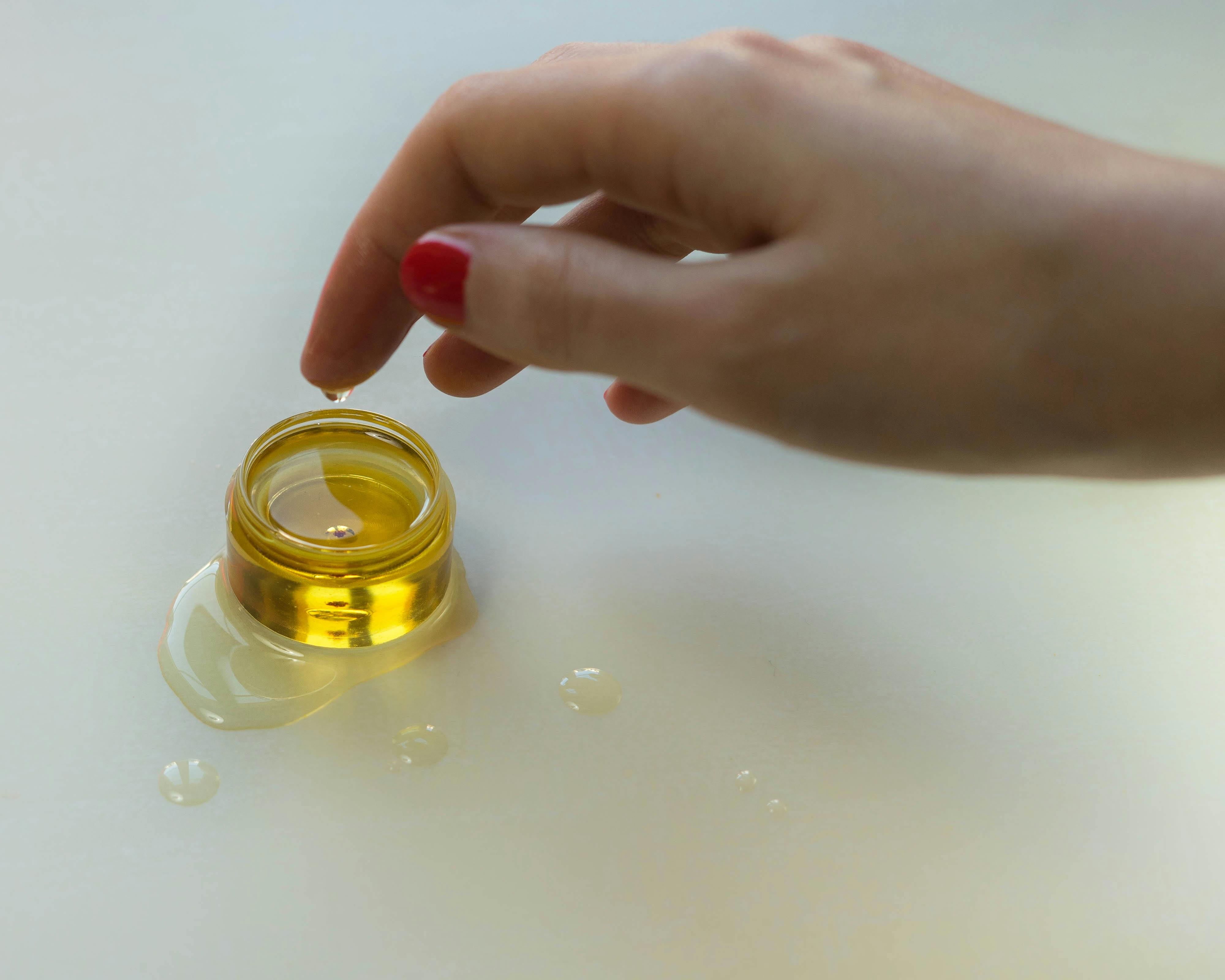 Person Holding a Dropper · Free Stock Photo