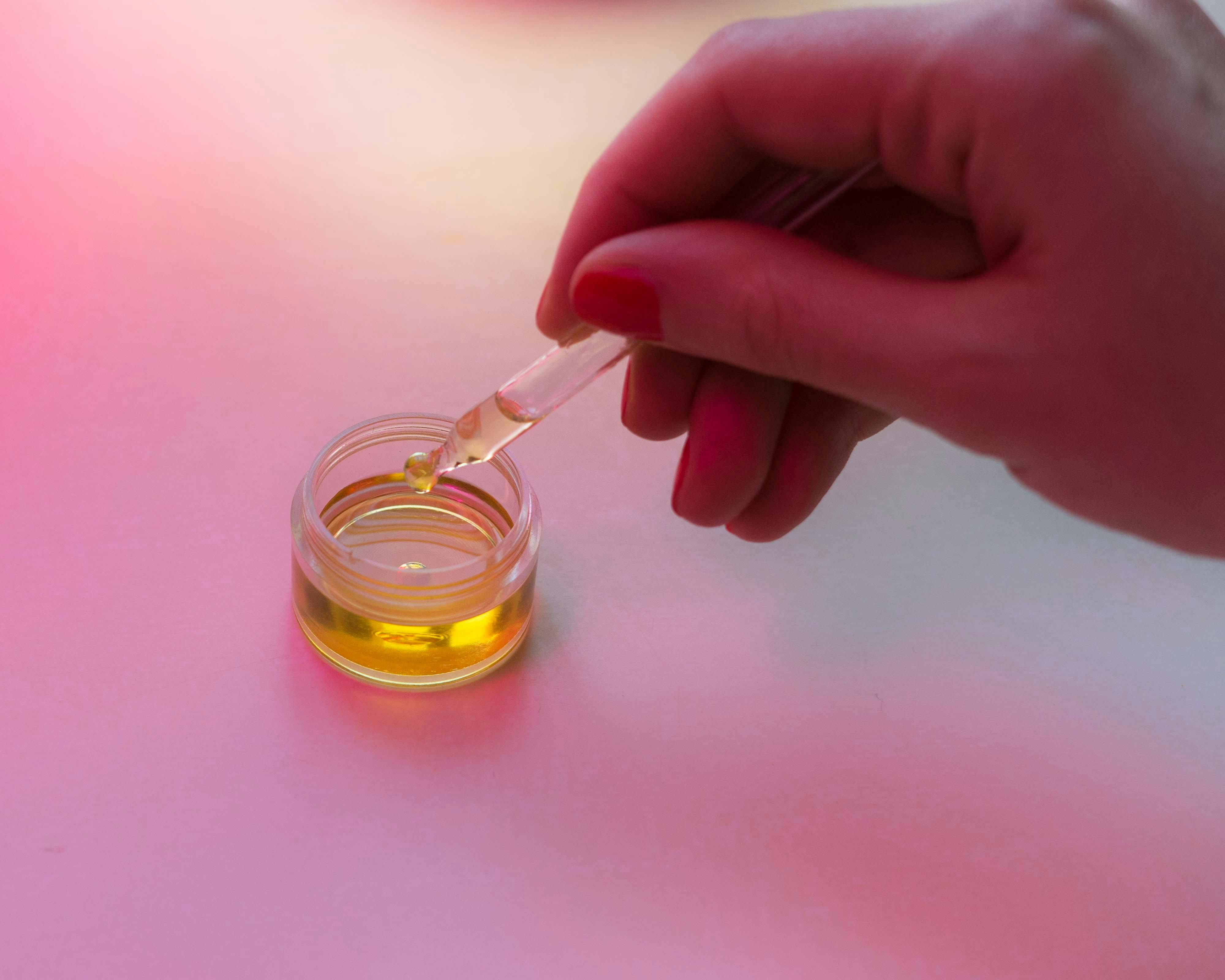 Person Holding a Dropper · Free Stock Photo