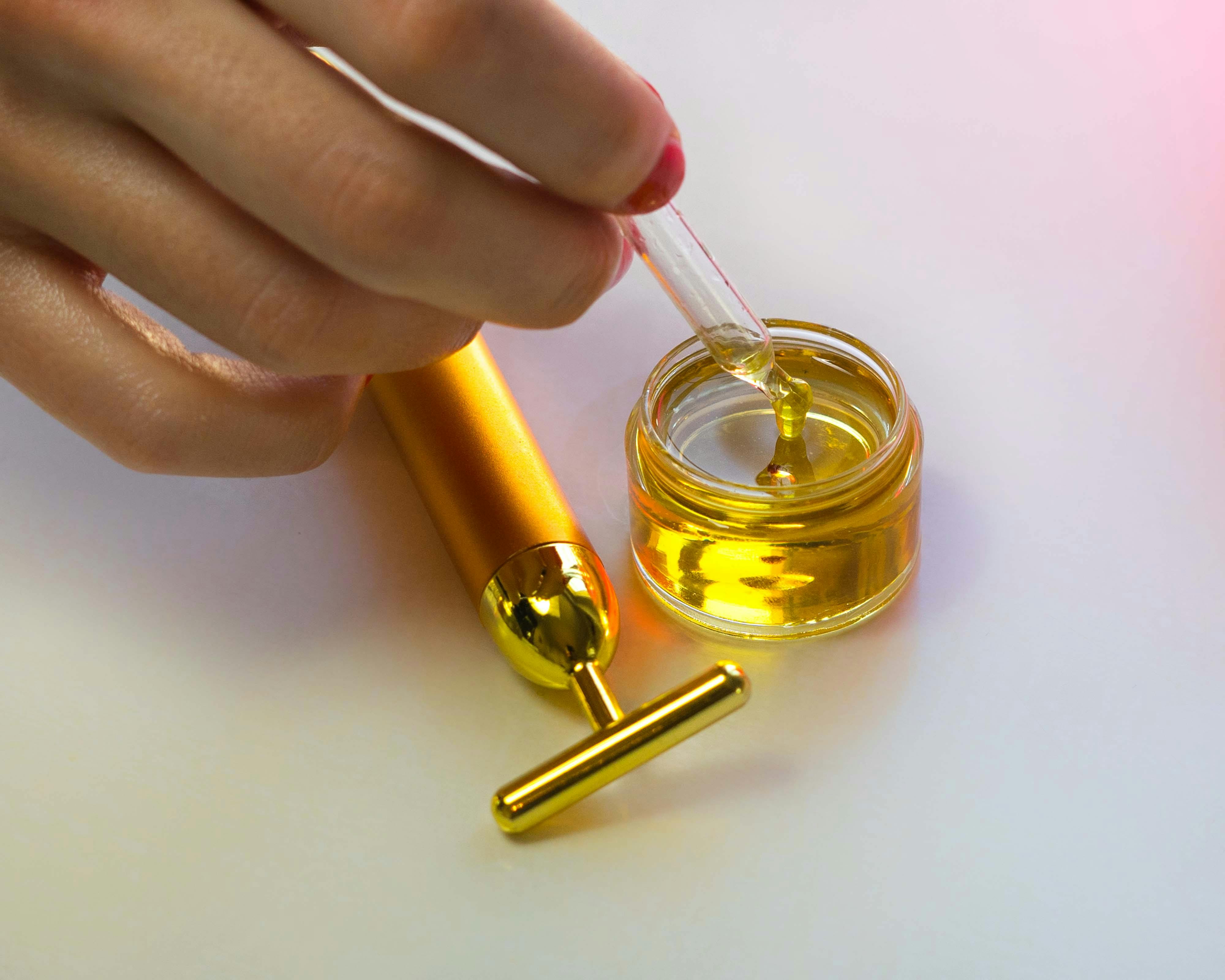 Person Holding a Dropper · Free Stock Photo