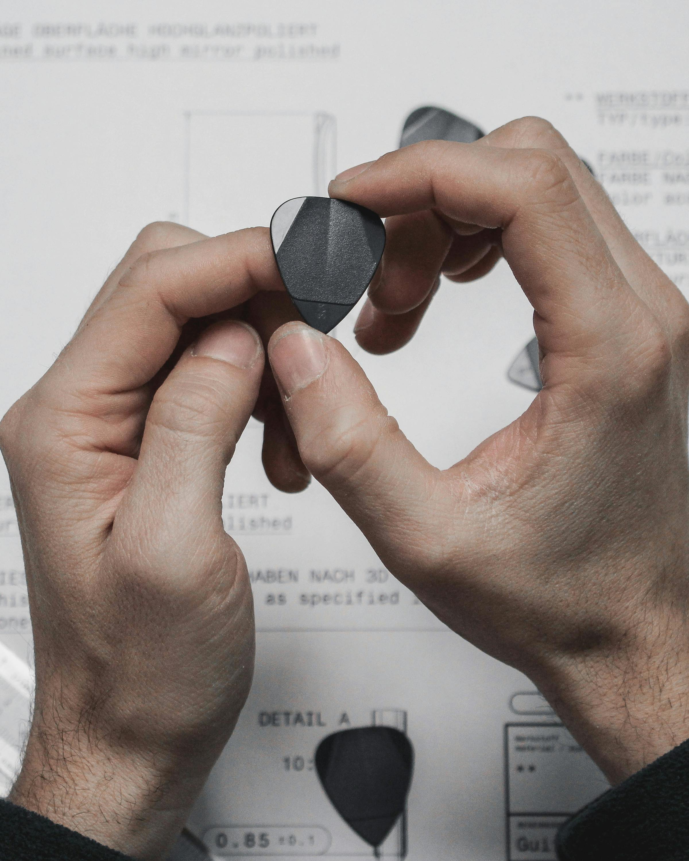 Person Holding a Paper Taped on a Wall · Free Stock Photo