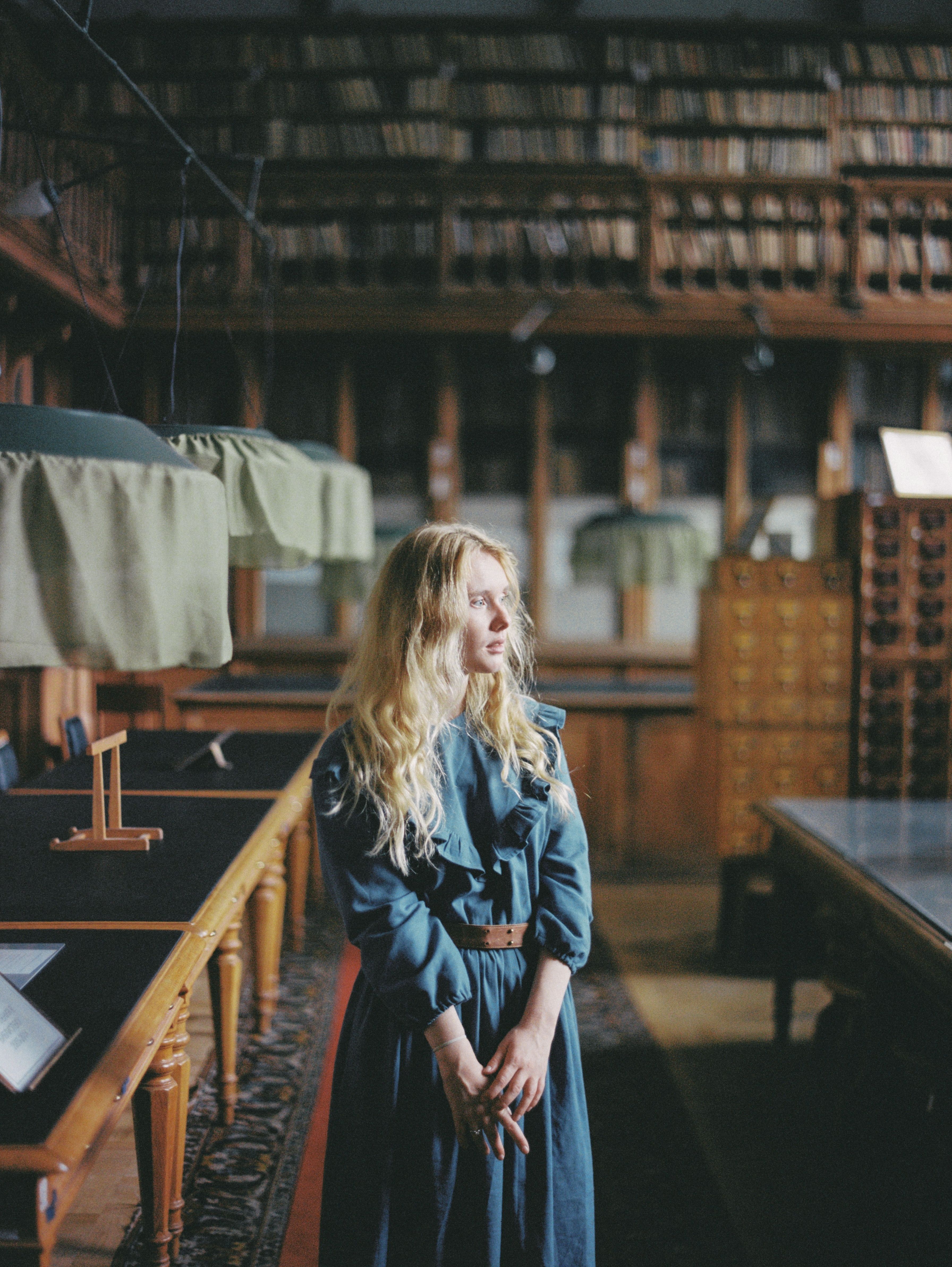 Woman in Blue Dress in a Library · Free Stock Photo