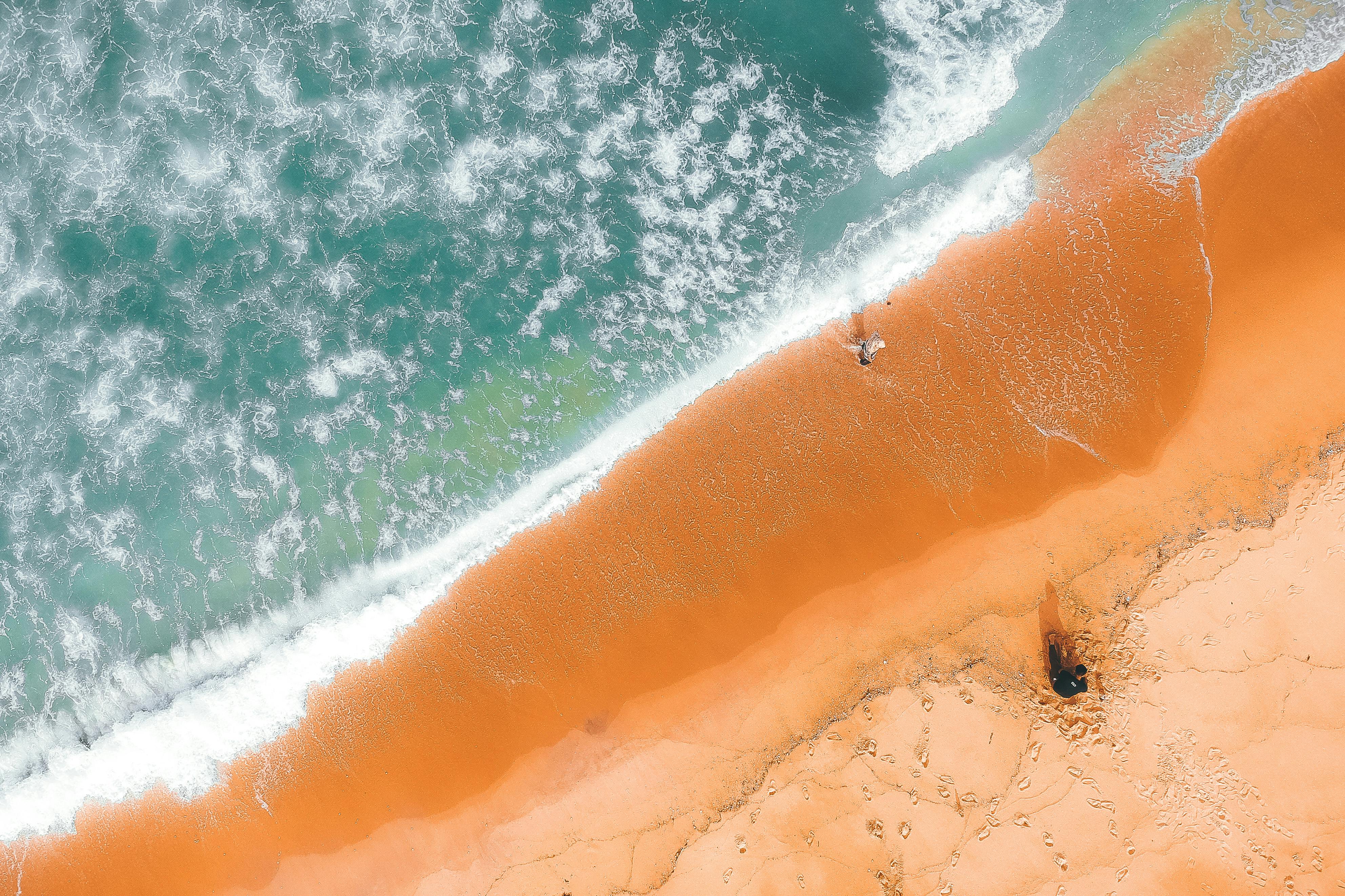 Glittering foamy sea water near bright sandy shore in sunlight · Free ...