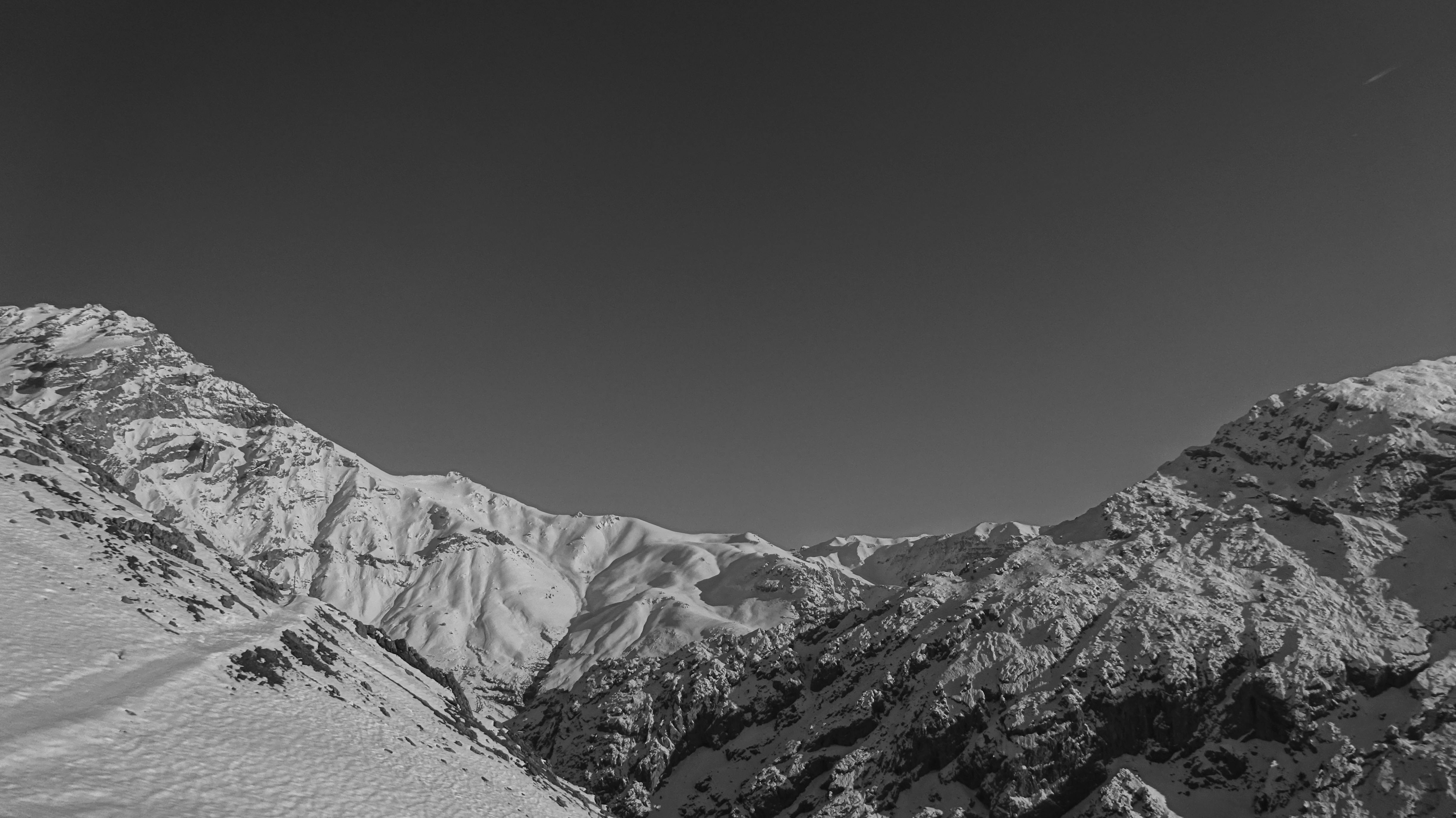 Peaks of steep mountains under cloudy sky · Free Stock Photo