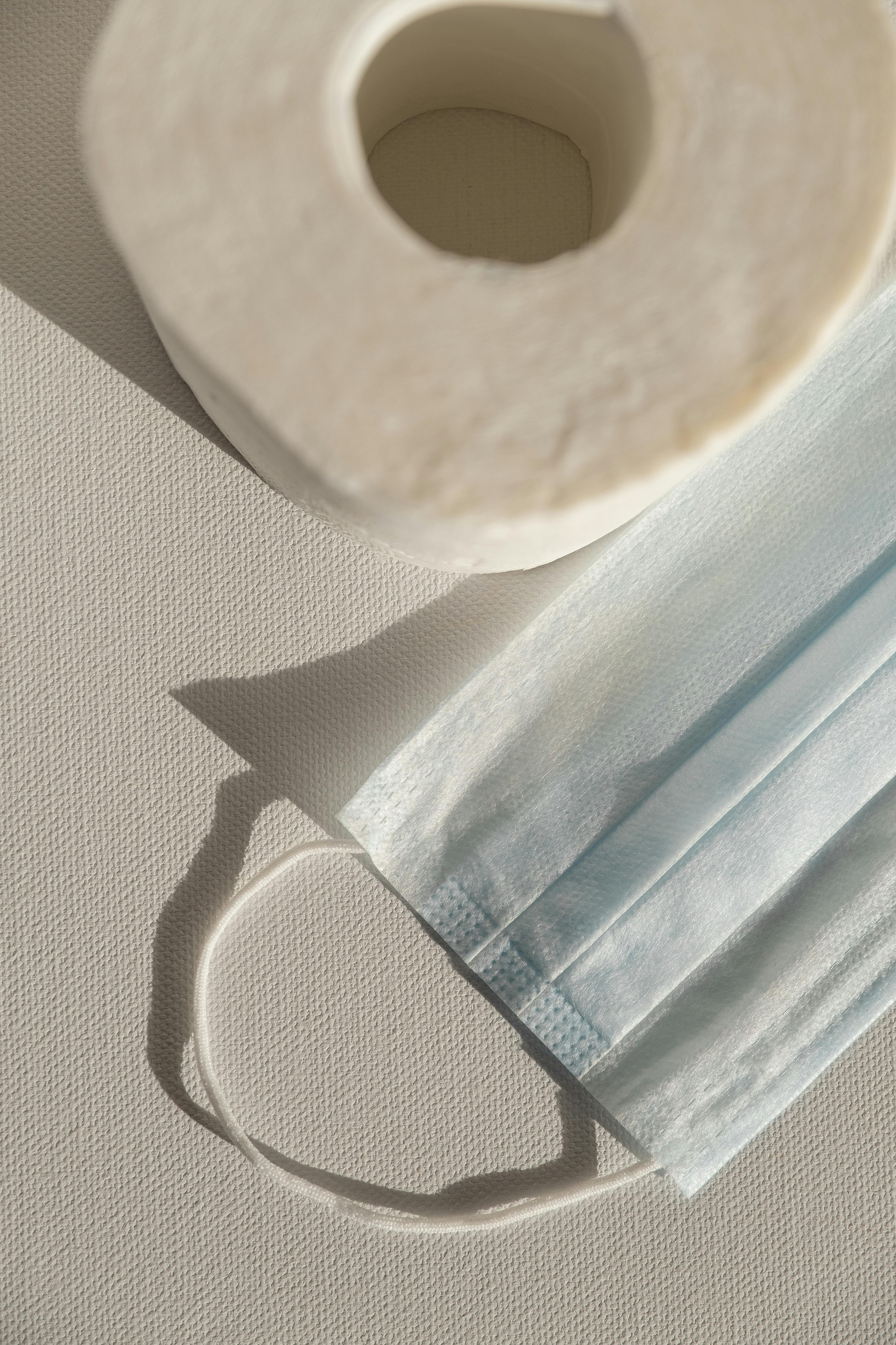 Close-Up Shot of a Tissue Paper Roll on a White Surface · Free Stock Photo