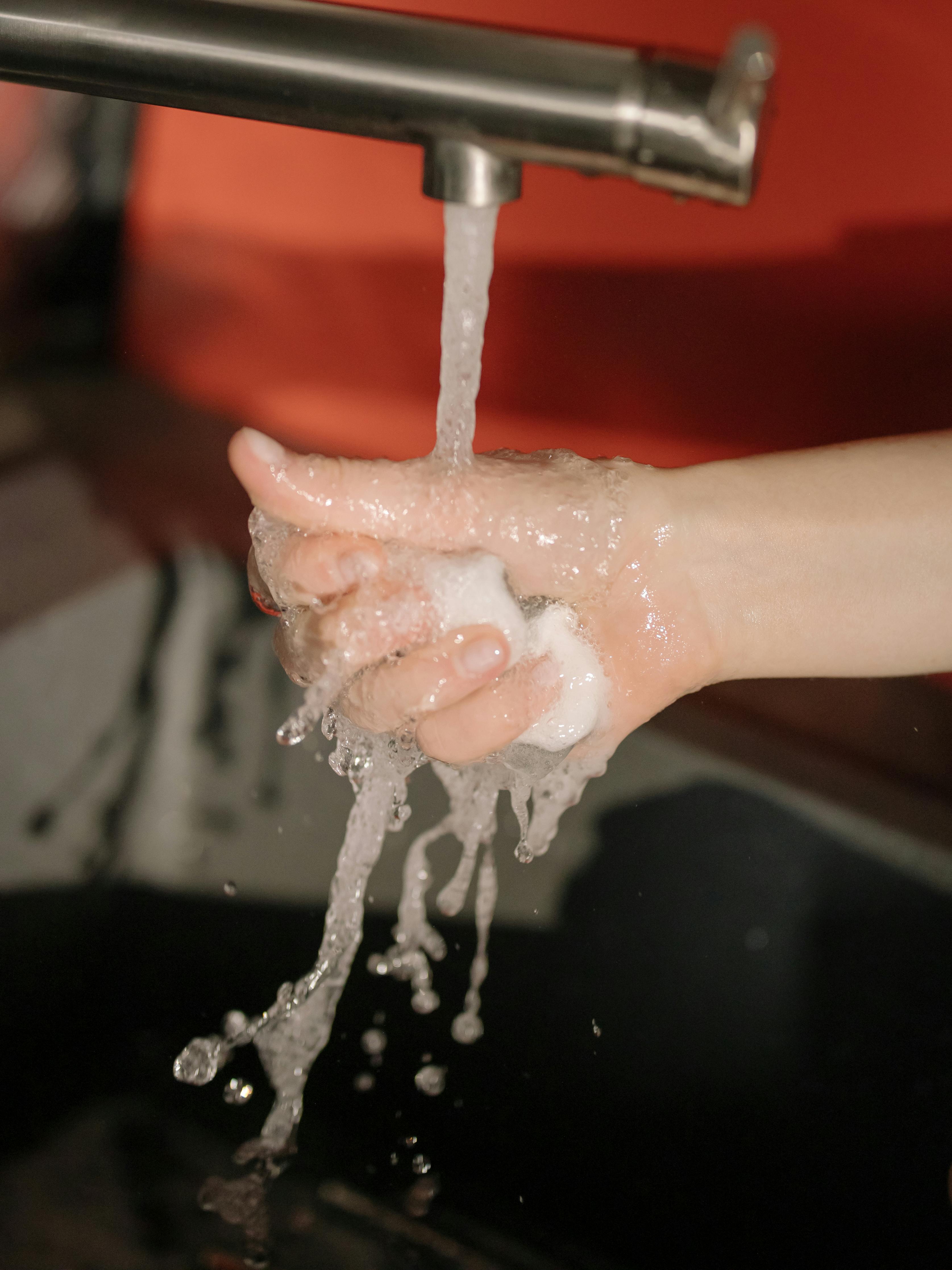 Person Washing Hands on Sink · Free Stock Photo