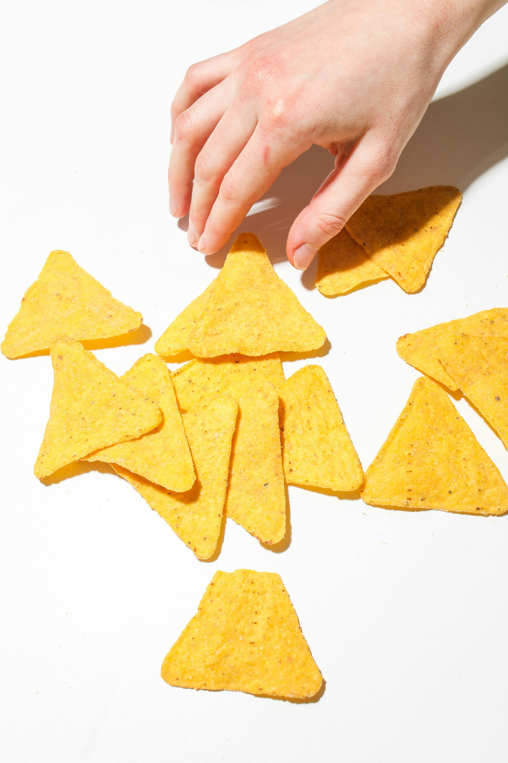 Person Getting a Piece of Chip · Free Stock Photo