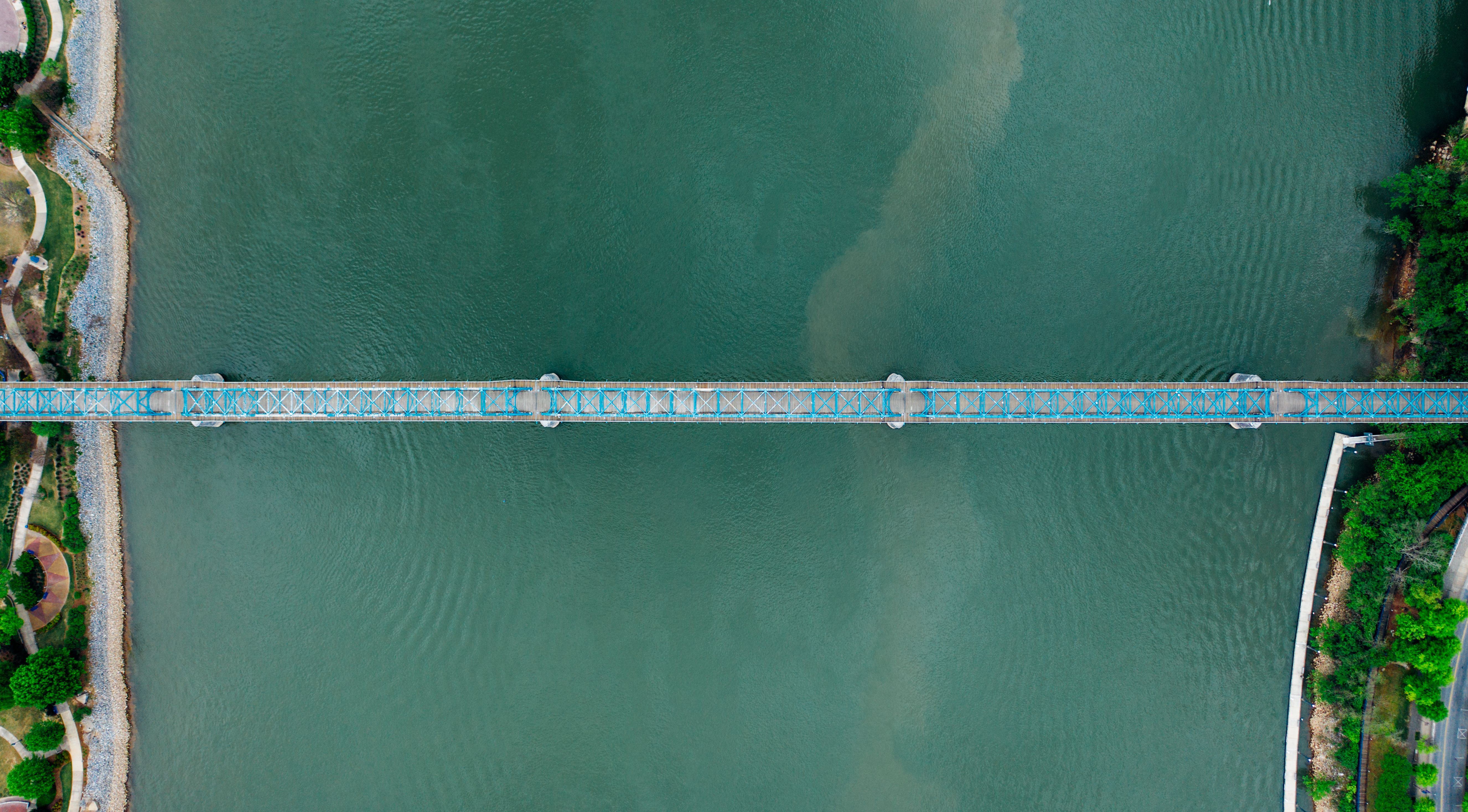 Modern bridge over river with blue ripple water · Free Stock Photo