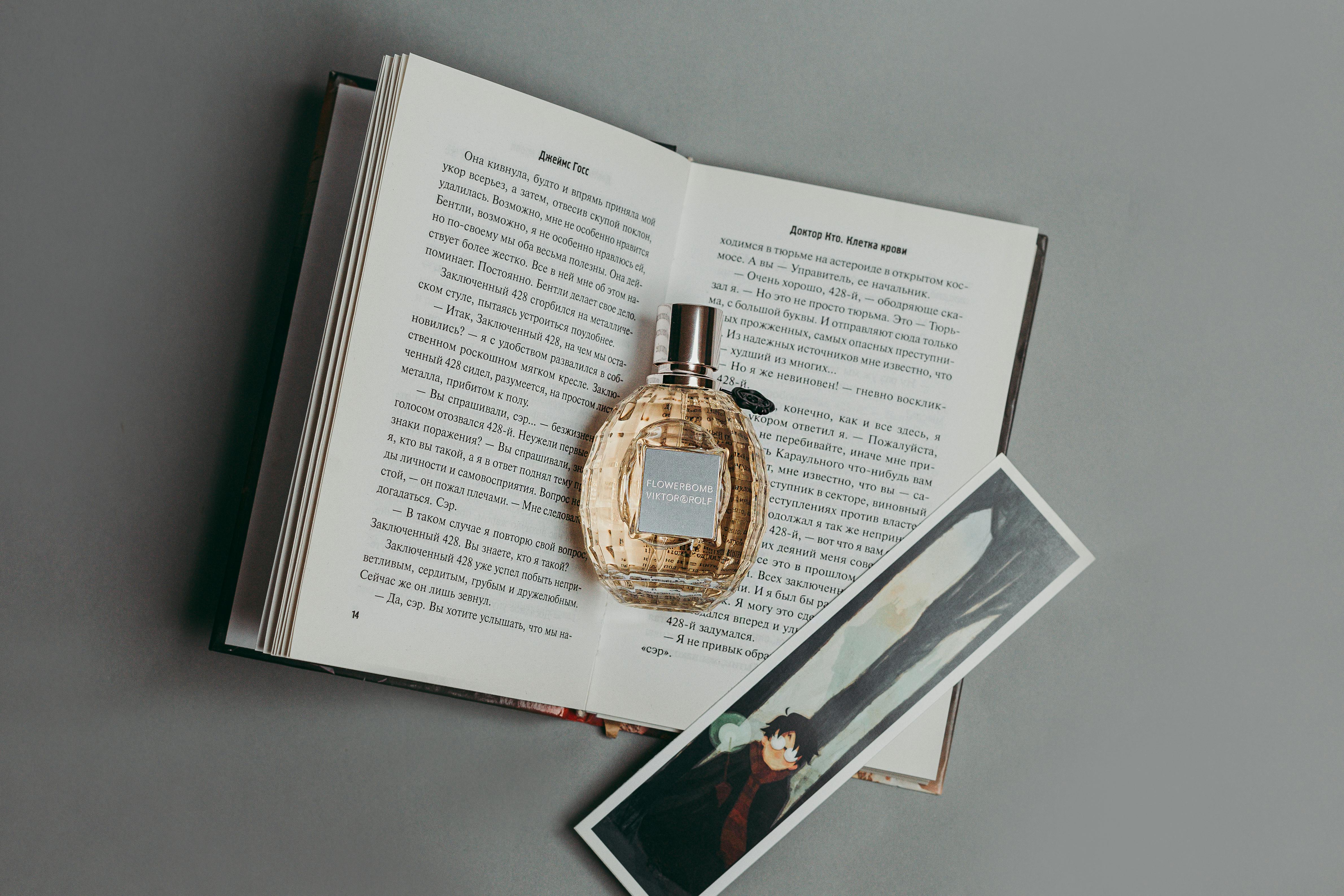 Photo Of Perfume On Top Of Book · Free Stock Photo