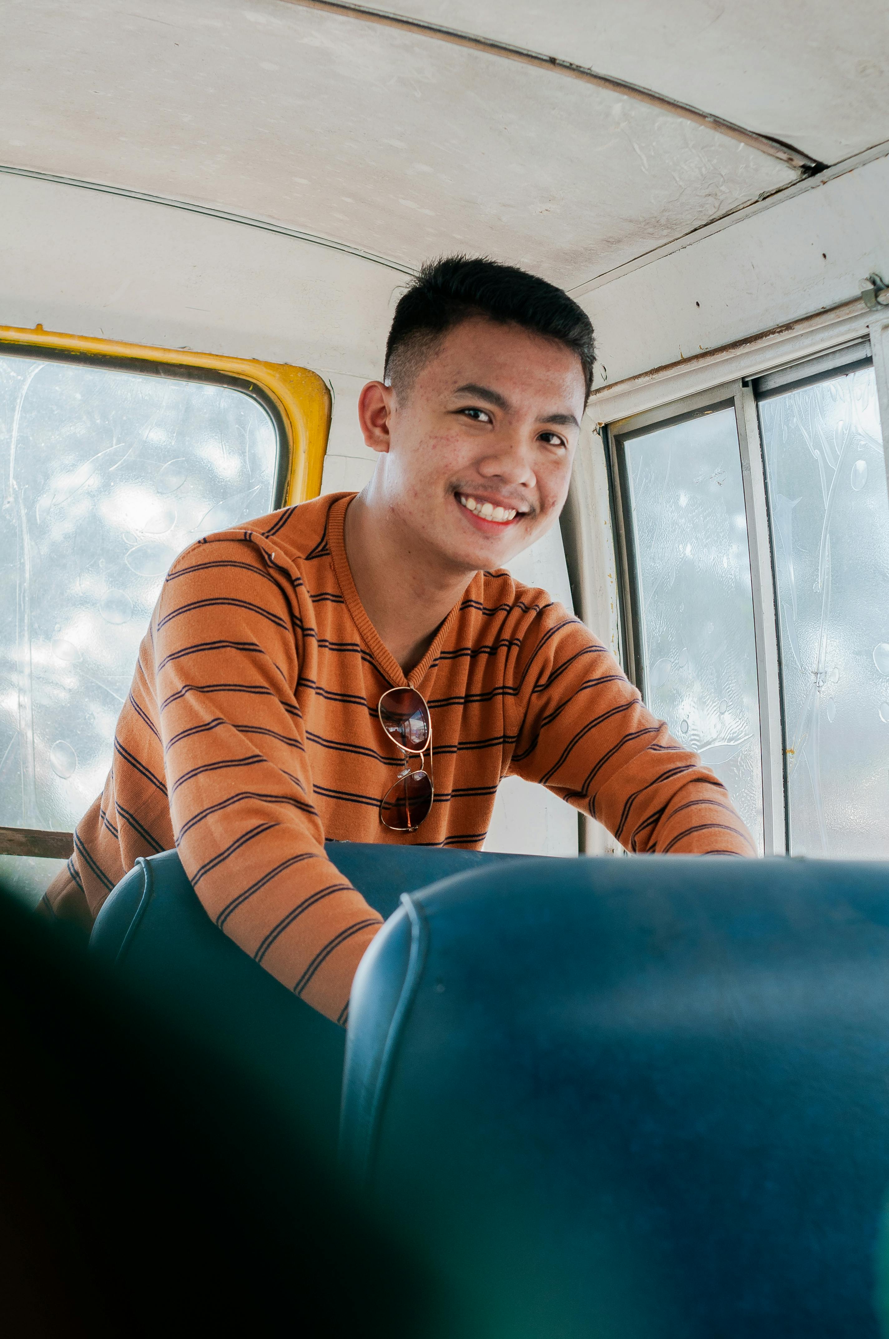 Smiling young guy riding bus · Free Stock Photo