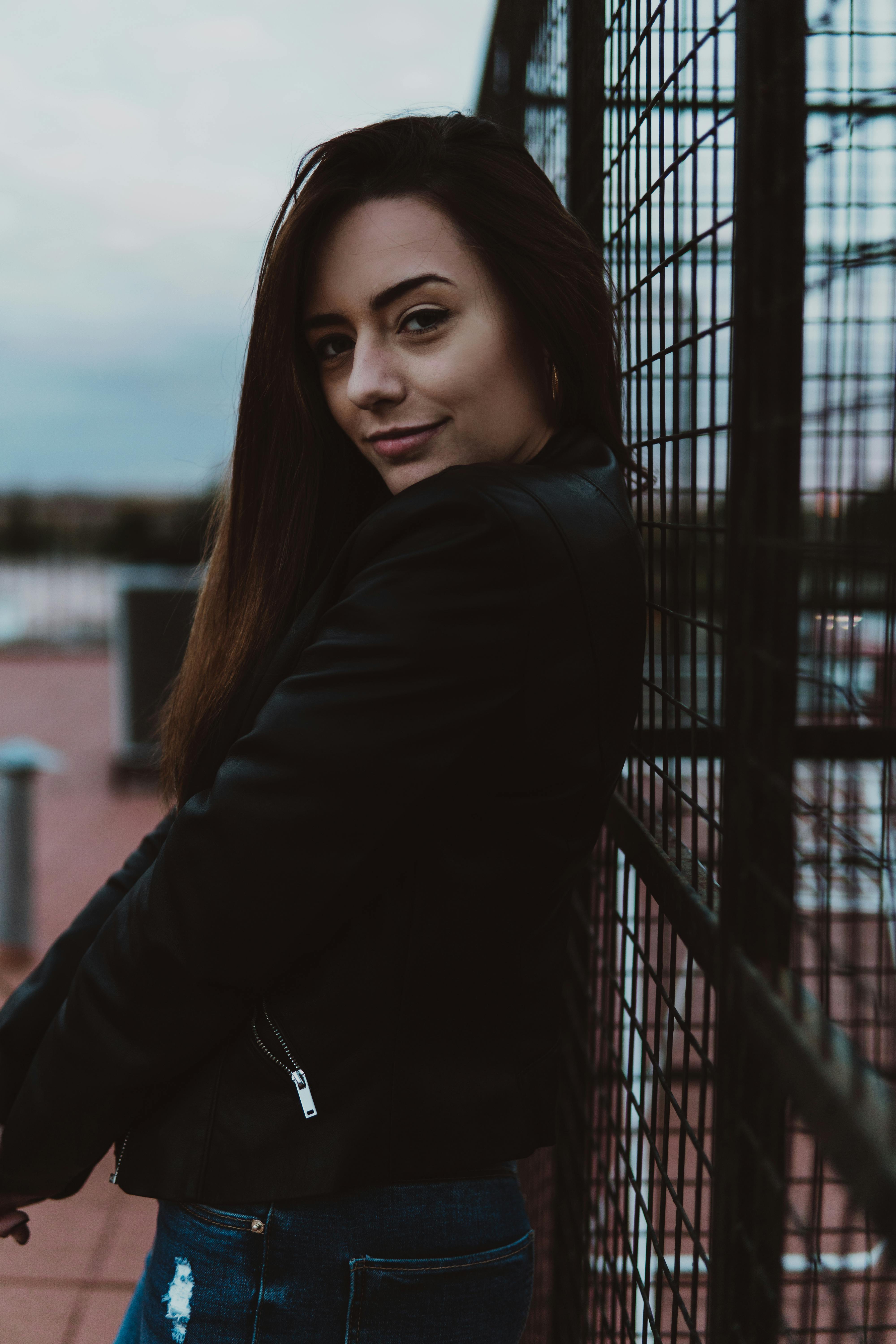 A Woman Removing Her Leather Jacket · Free Stock Photo