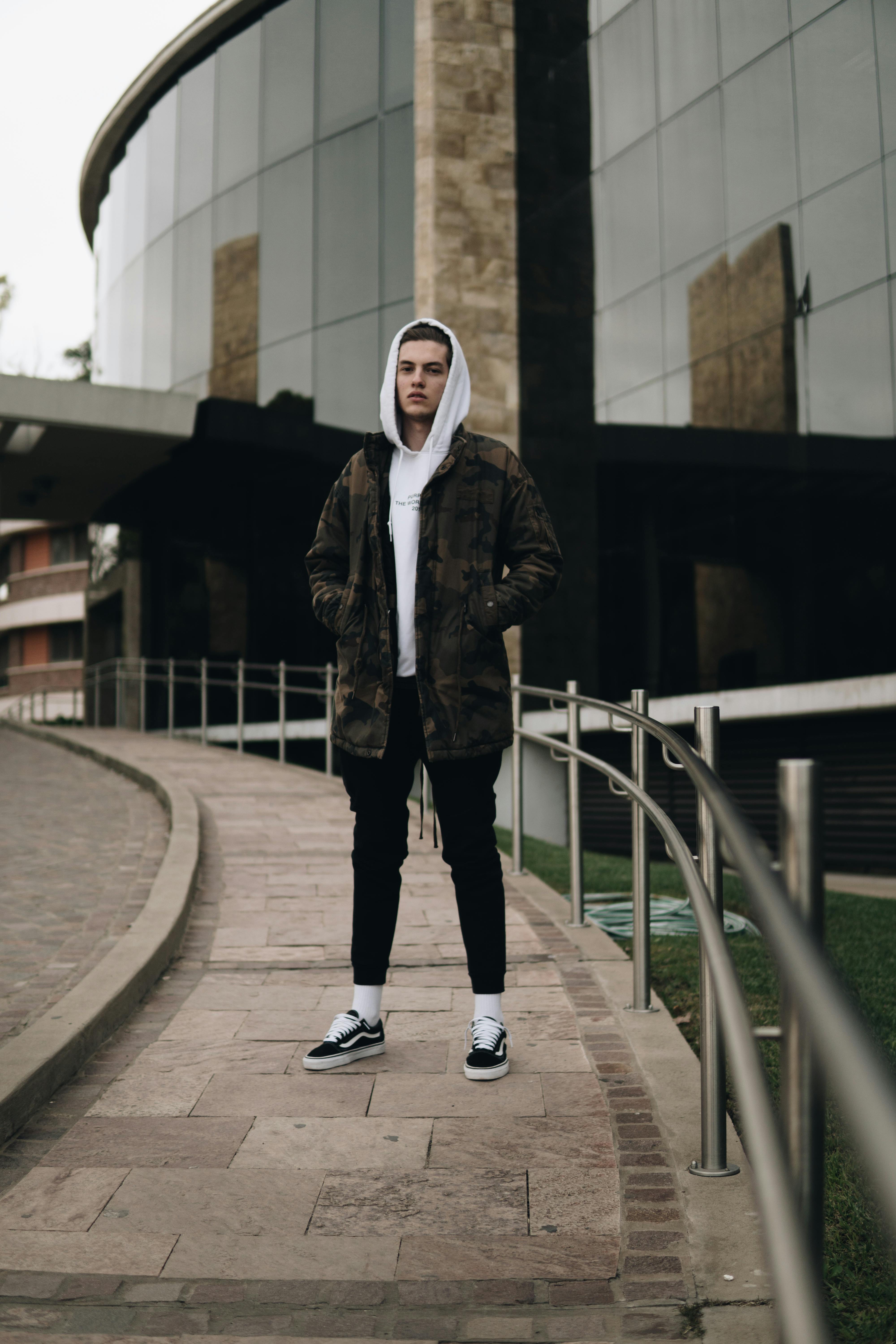 Street Photography of a Man in a Jacket and a Hoodie · Free Stock Photo