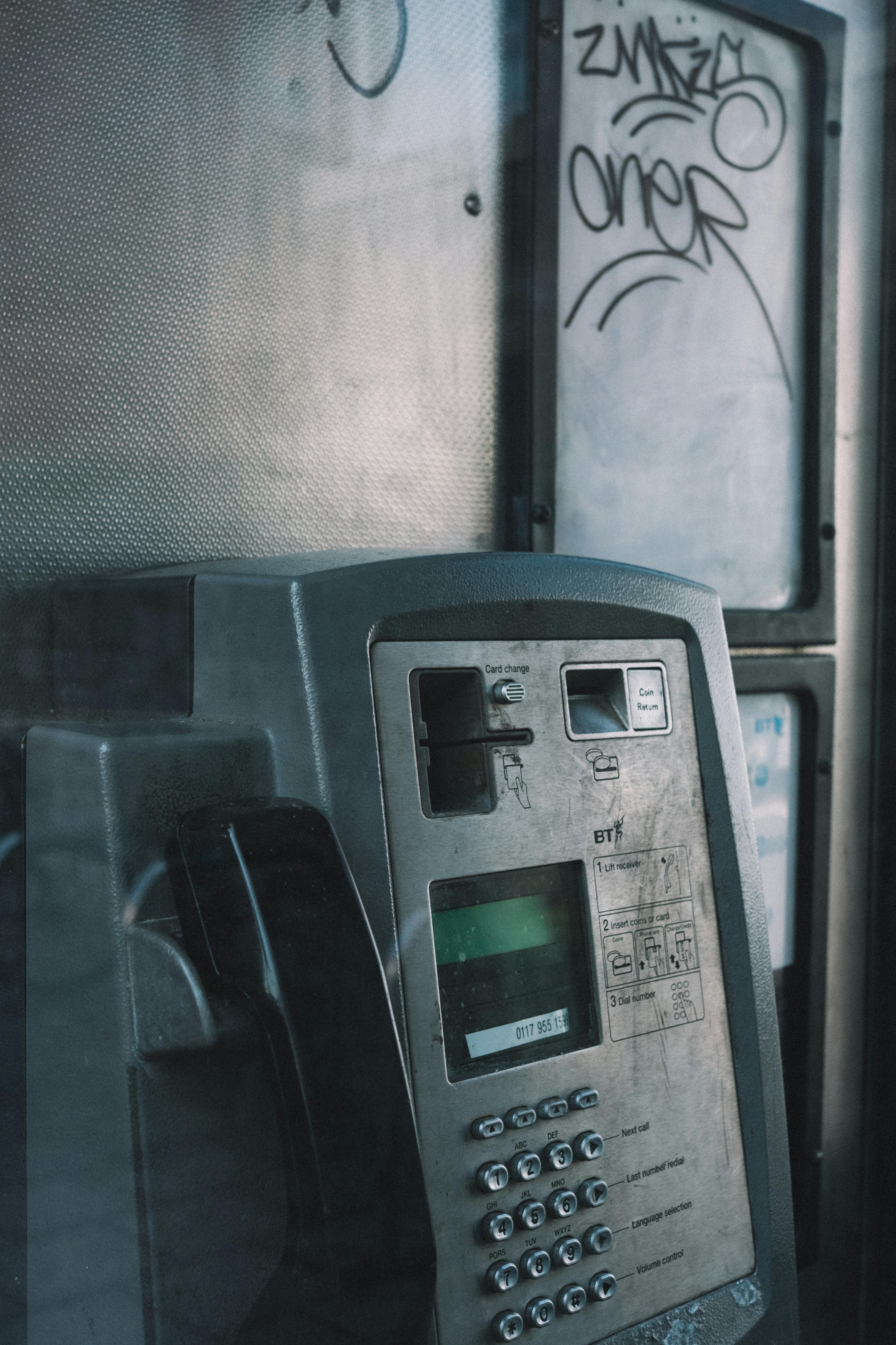 Old metal public payphone hanging on shabby wall · Free Stock Photo