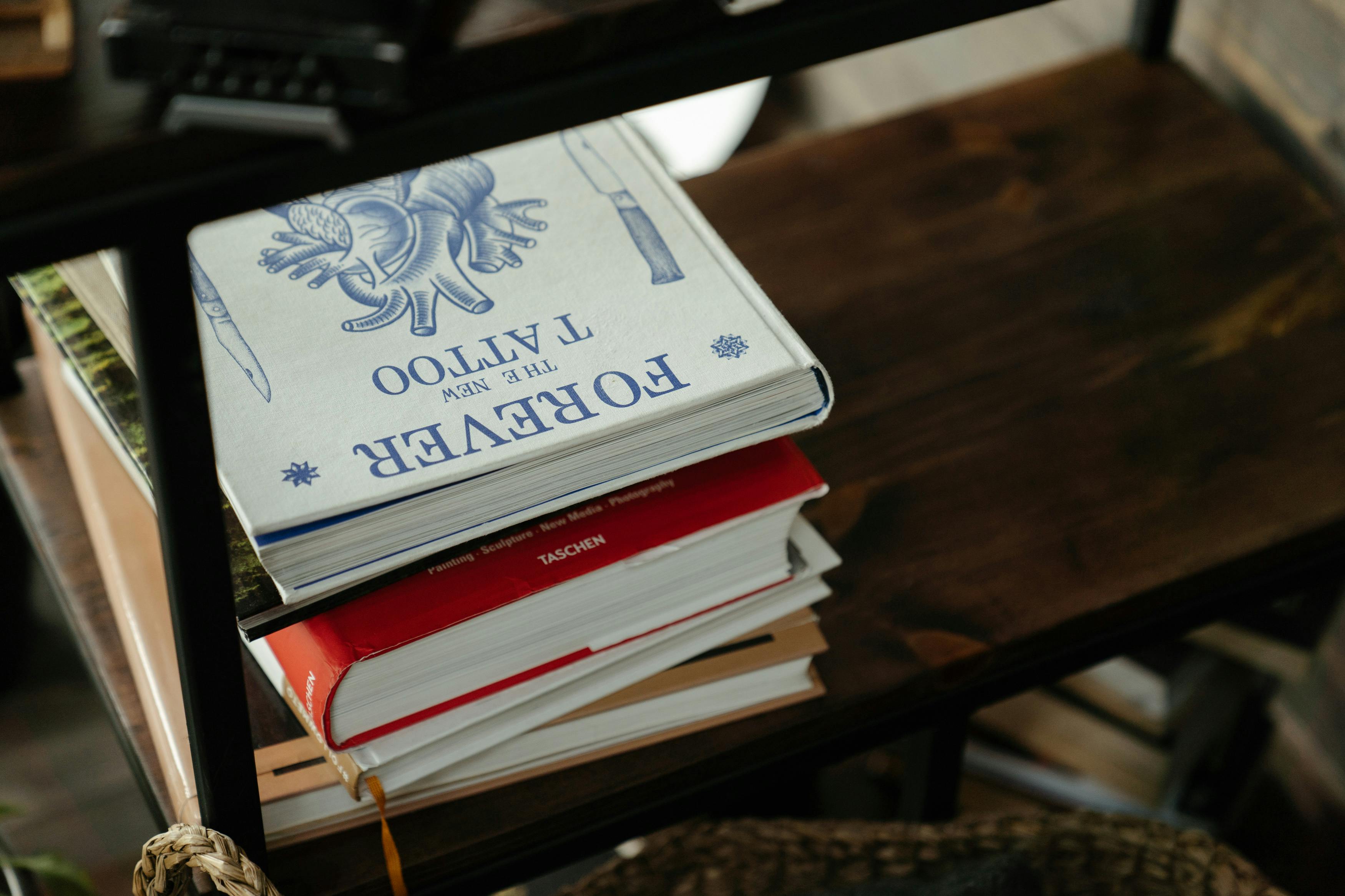 White and Blue Book on Brown Wooden Table · Free Stock Photo