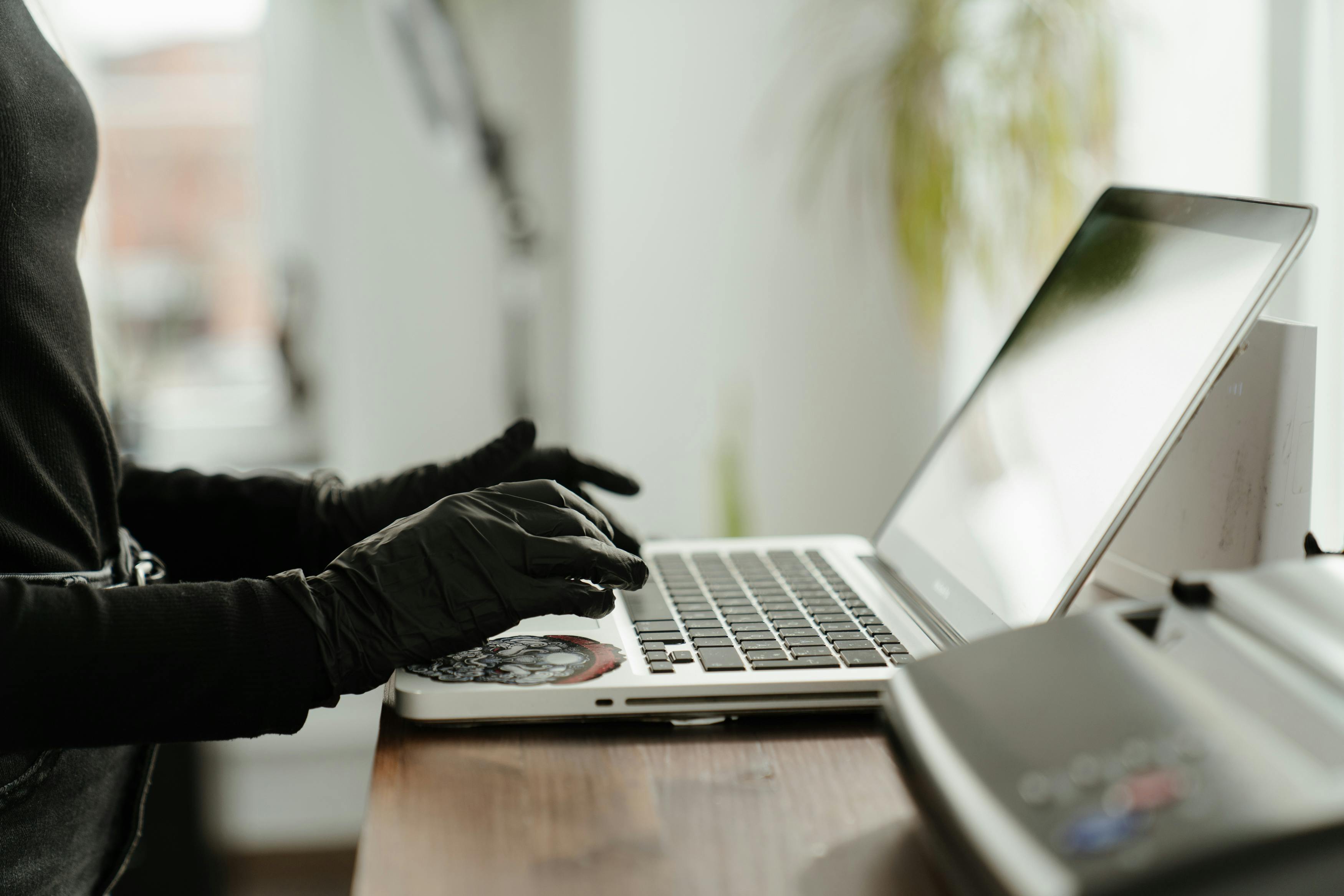 Person Using Macbook Pro on Brown Wooden Table · Free Stock Photo