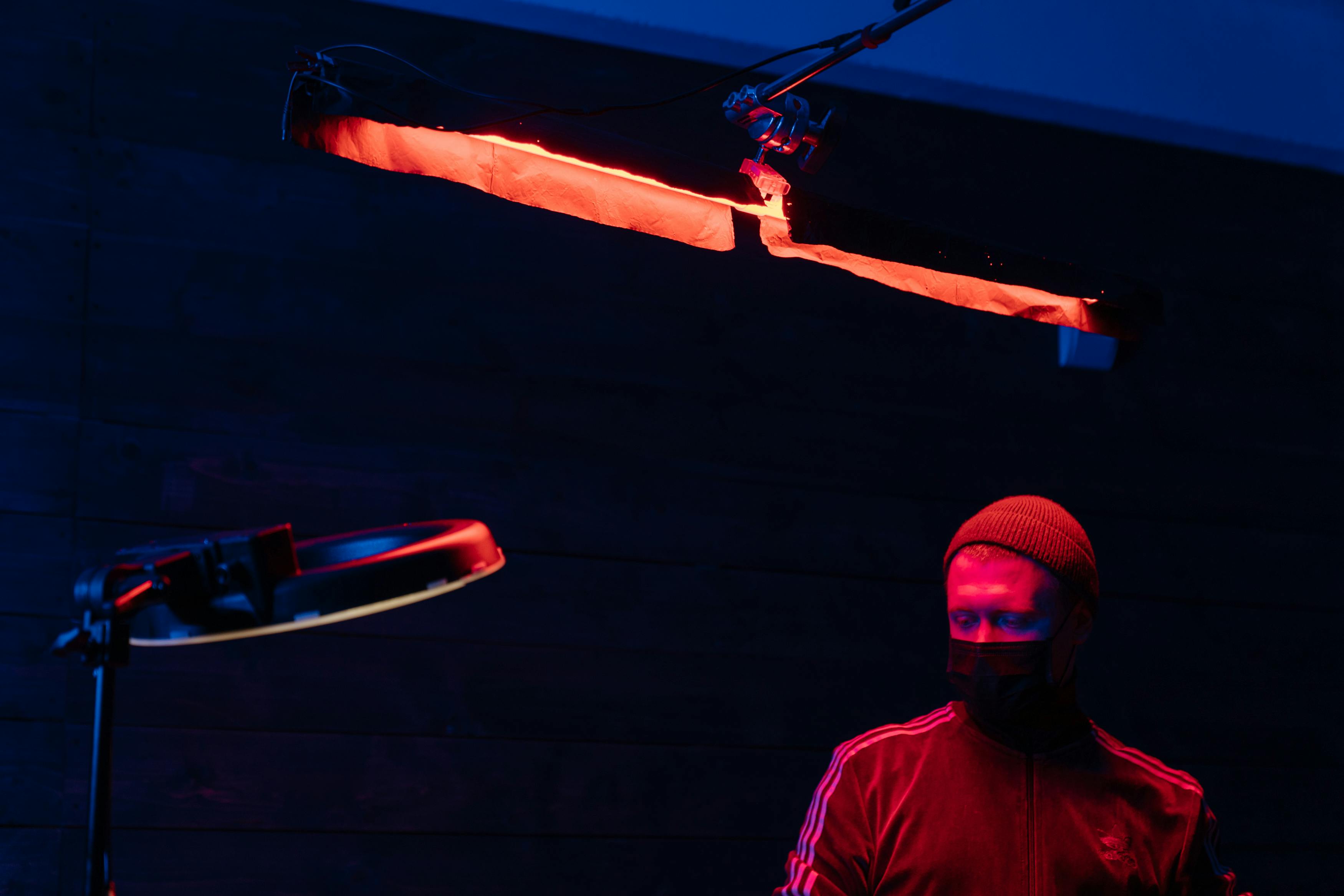 Man in Red Knit Cap Holding Red Light · Free Stock Photo