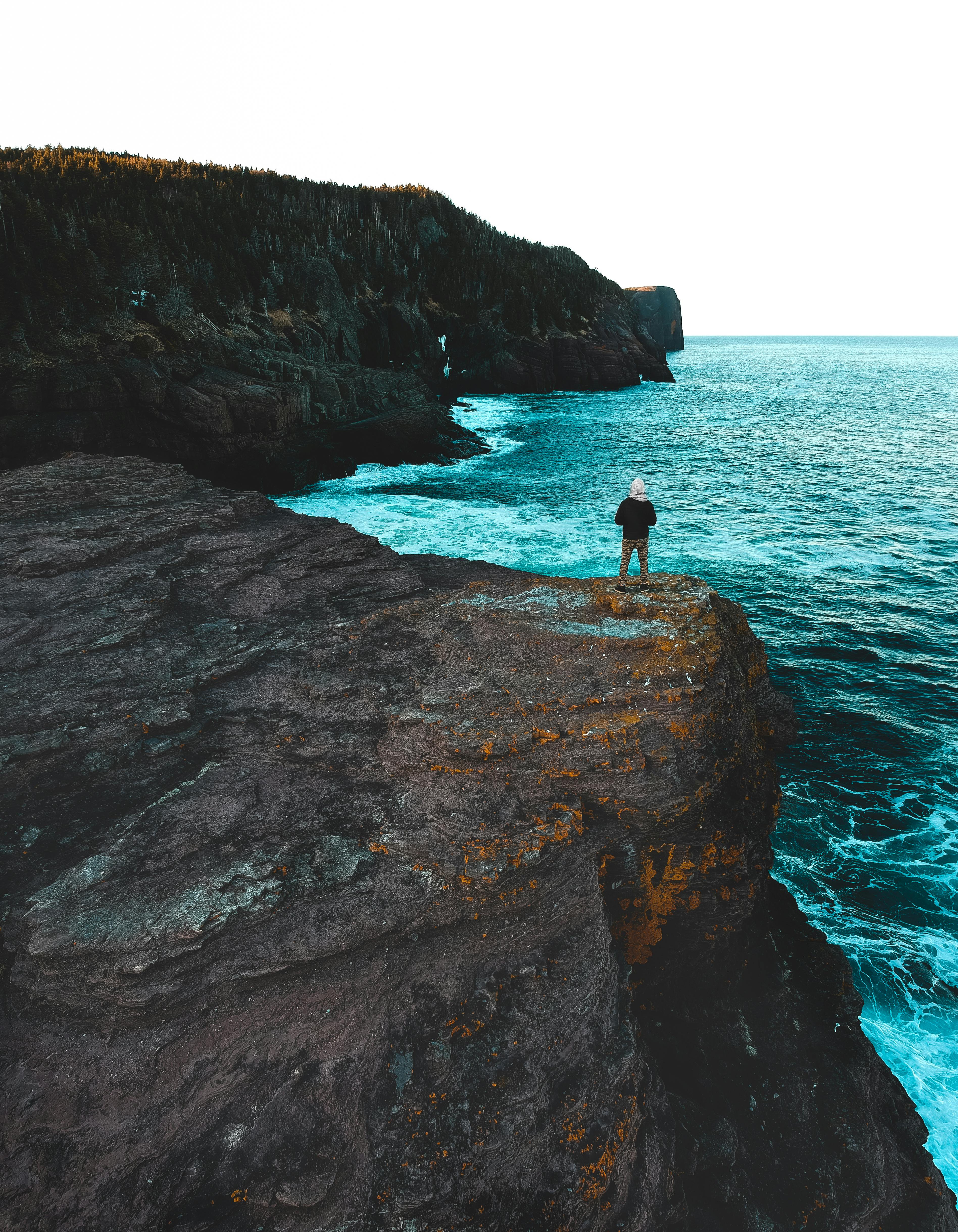 Photo Of Person Standing On Cliff Edge · Free Stock Photo