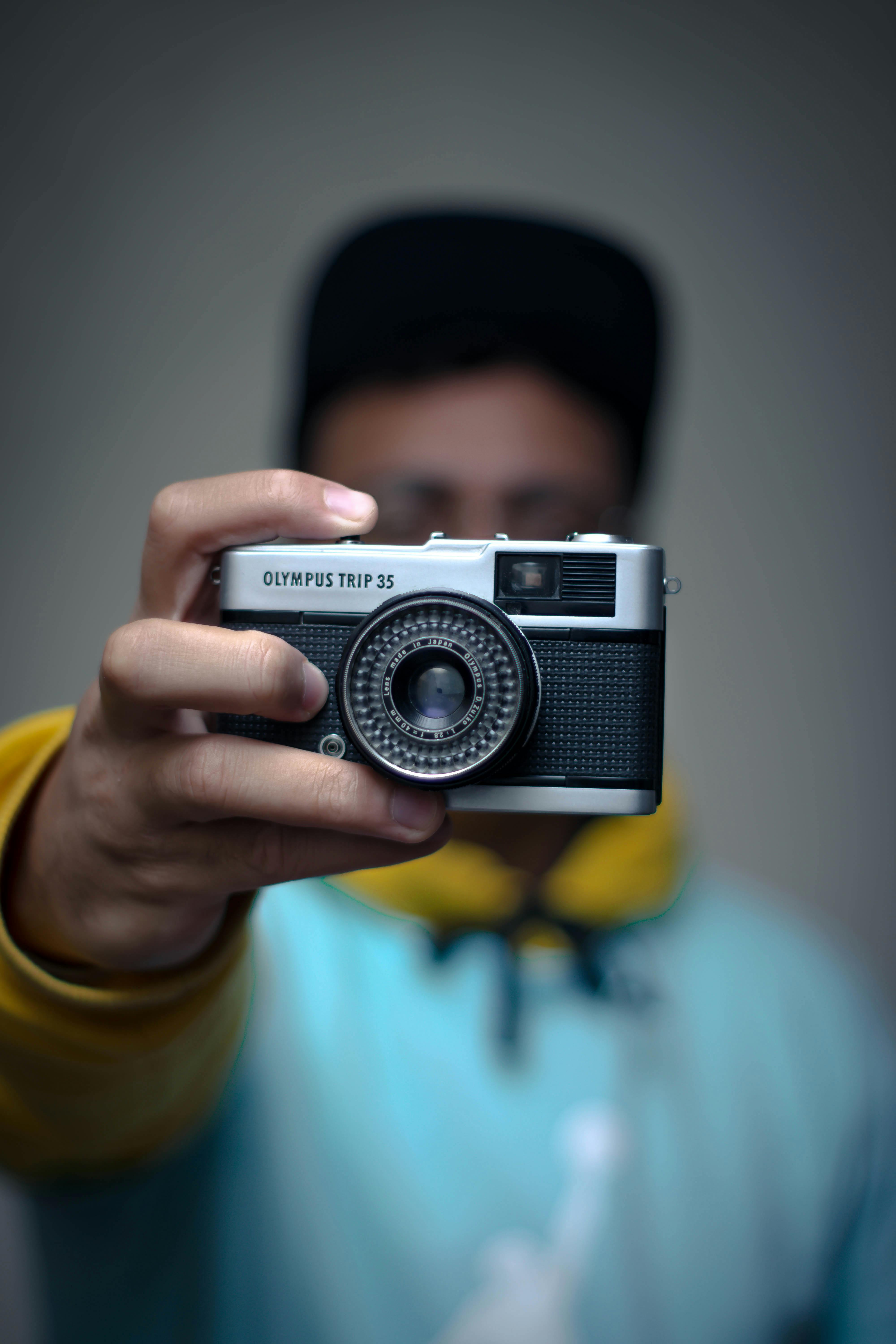 Faceless man using vintage photo camera · Free Stock Photo