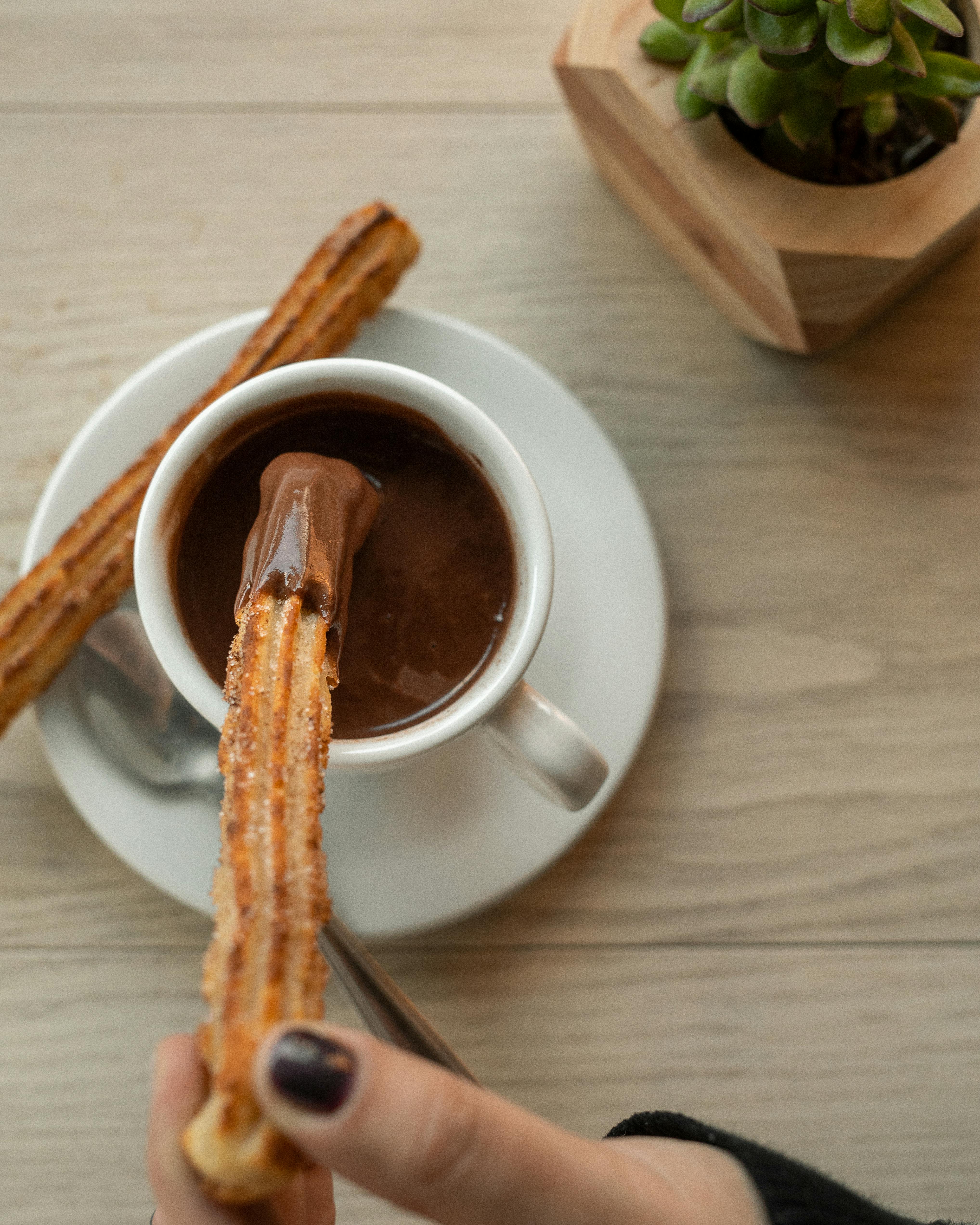 Photo Of Person Holding Churros · Free Stock Photo