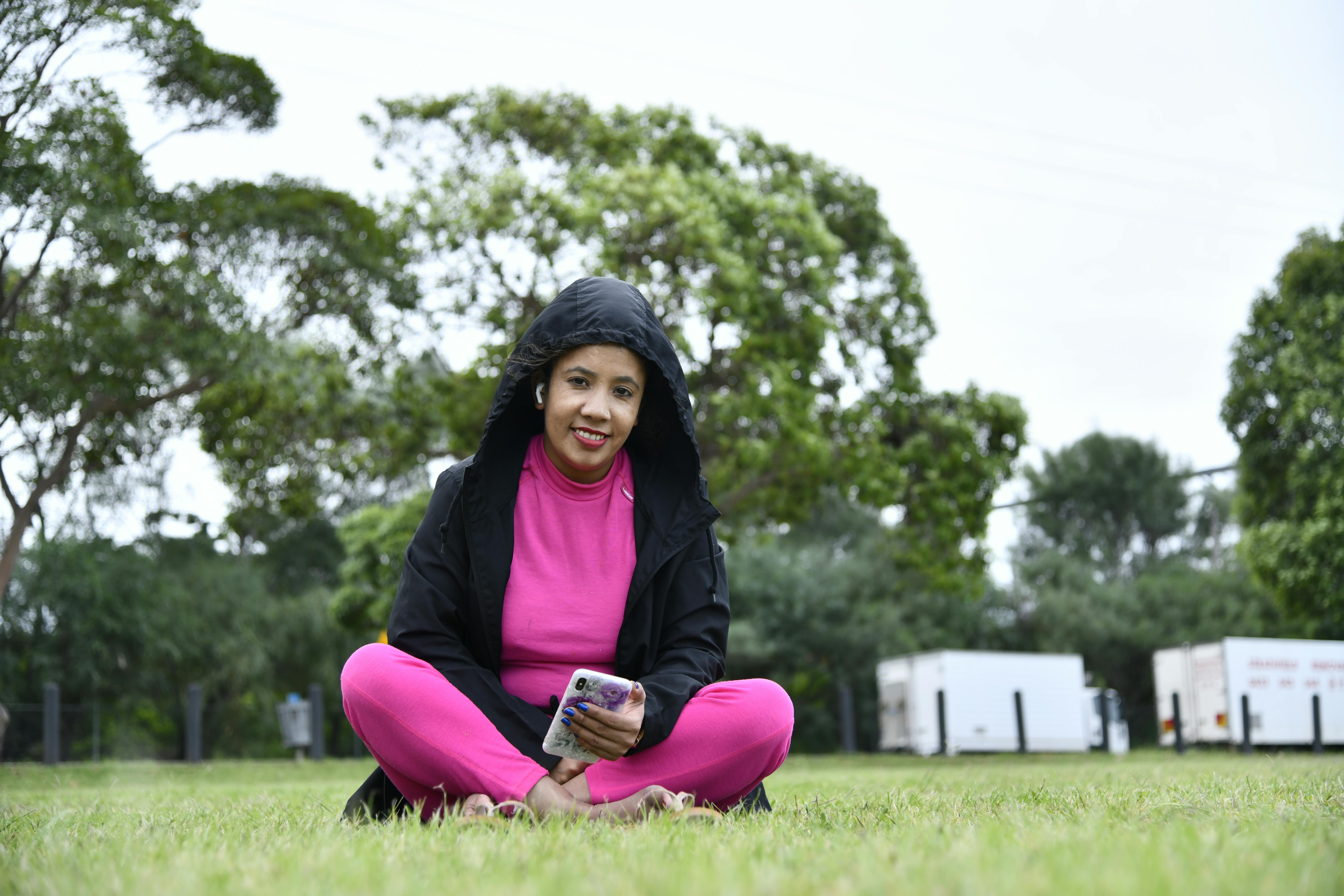 Cheerful woman on grass lawn in countryside · Free Stock Photo