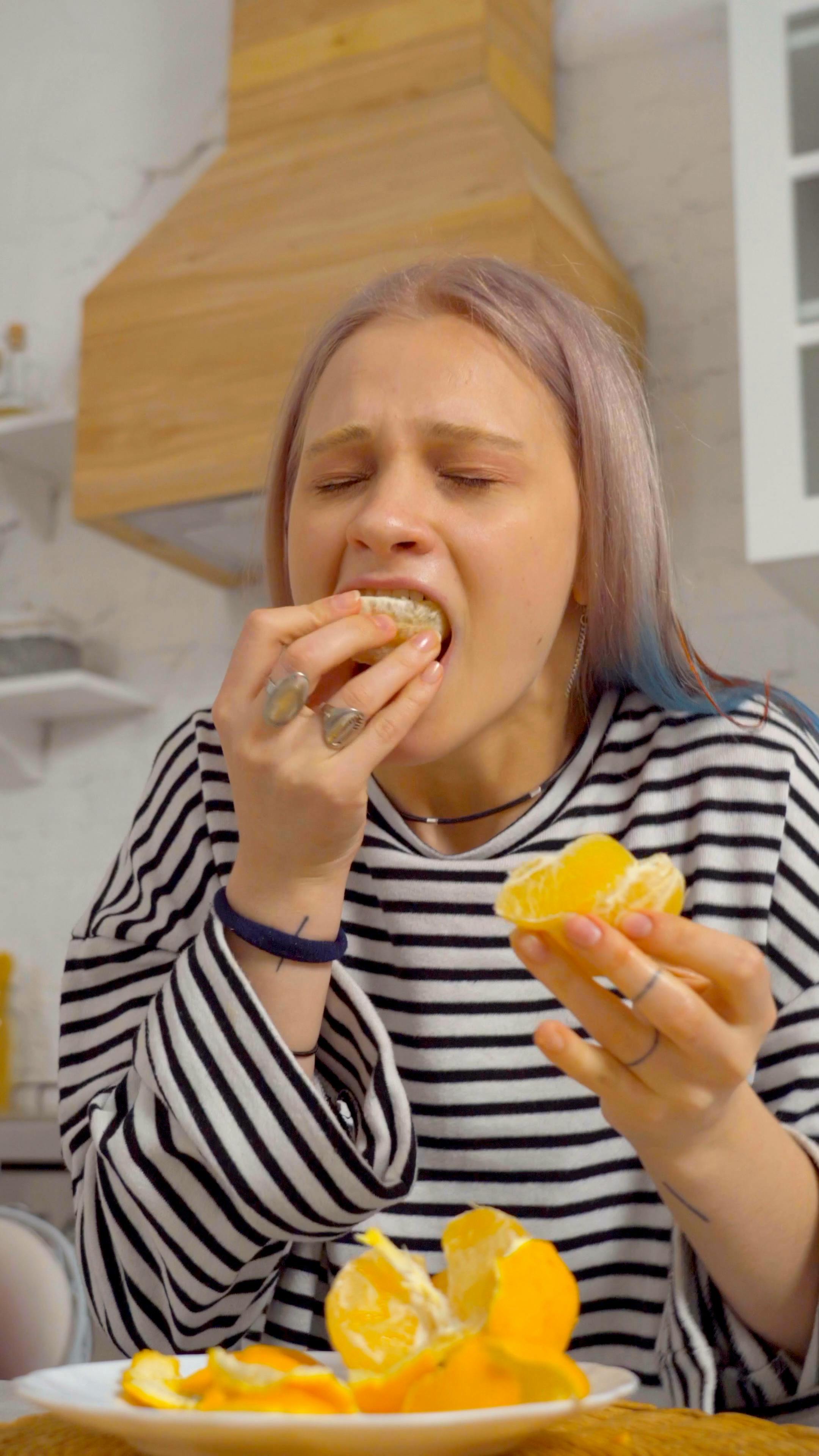 Woman with Colored Hair Eating Fruit · Free Stock Photo