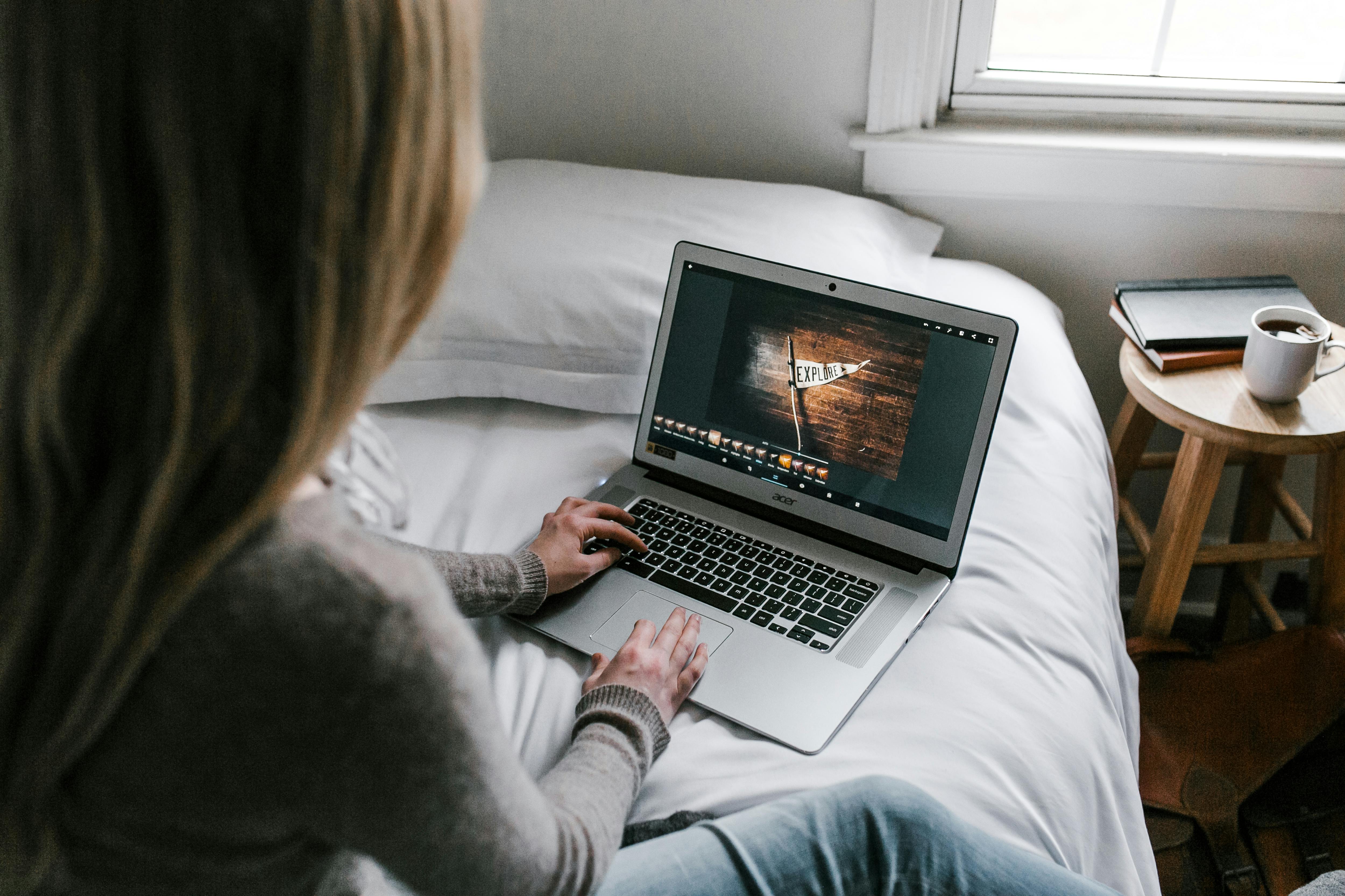 Woman in Gray Sweater Using Macbook Pro · Free Stock Photo