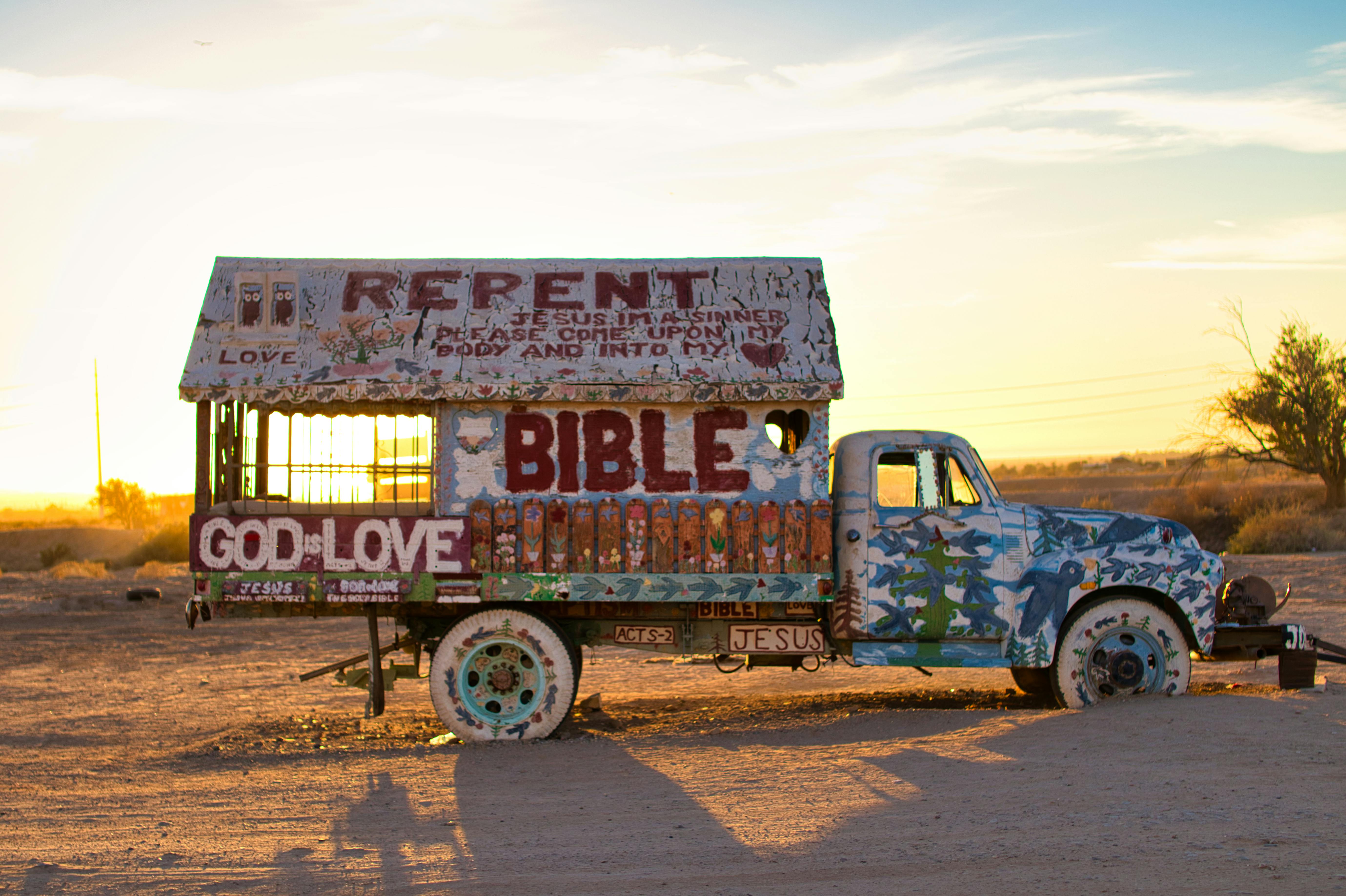 Abandoned Truck with Religious Slogans on Desert · Free Stock Photo